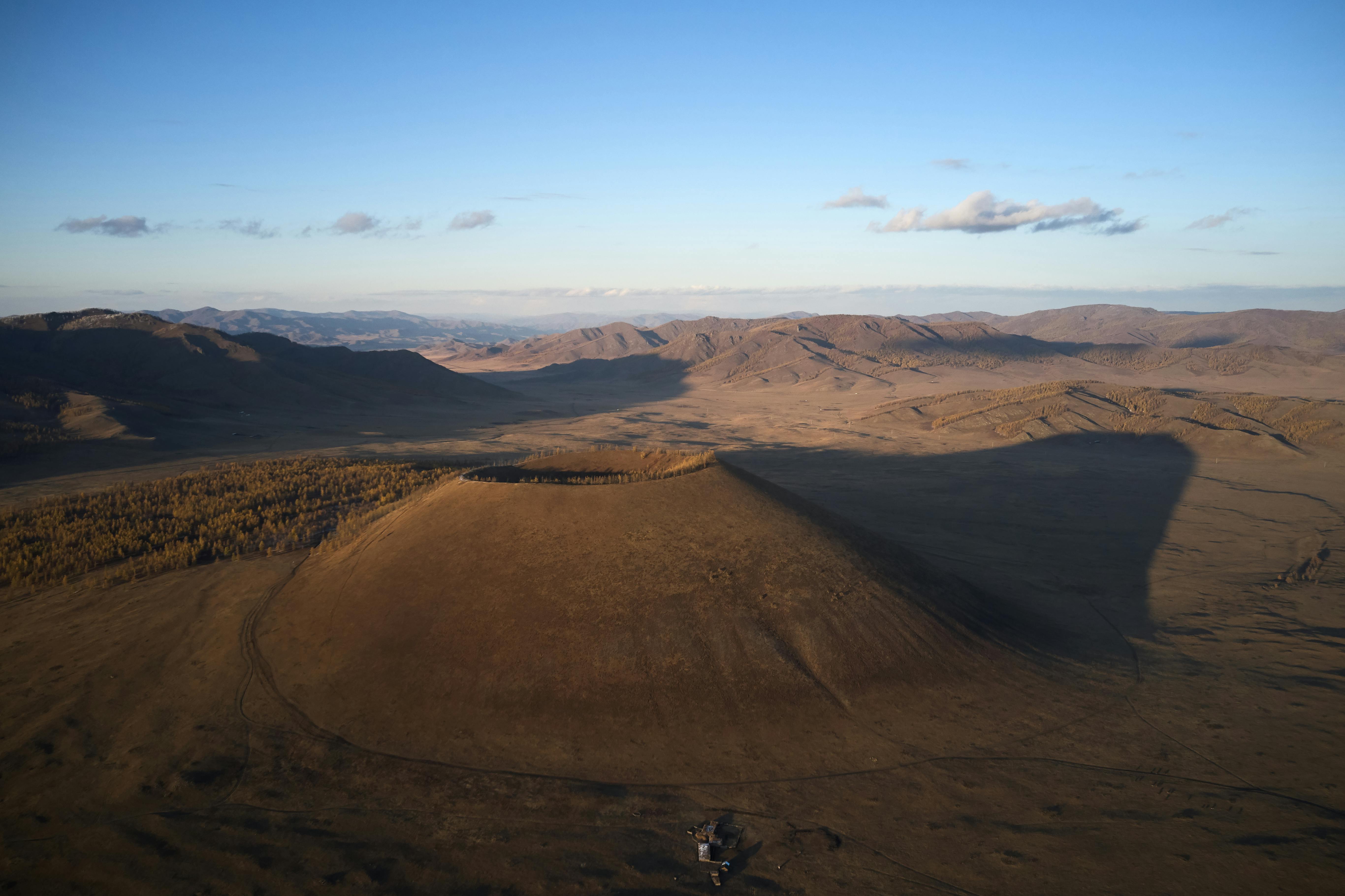 Volcano crater in vast valley at sundown · Free Stock Photo