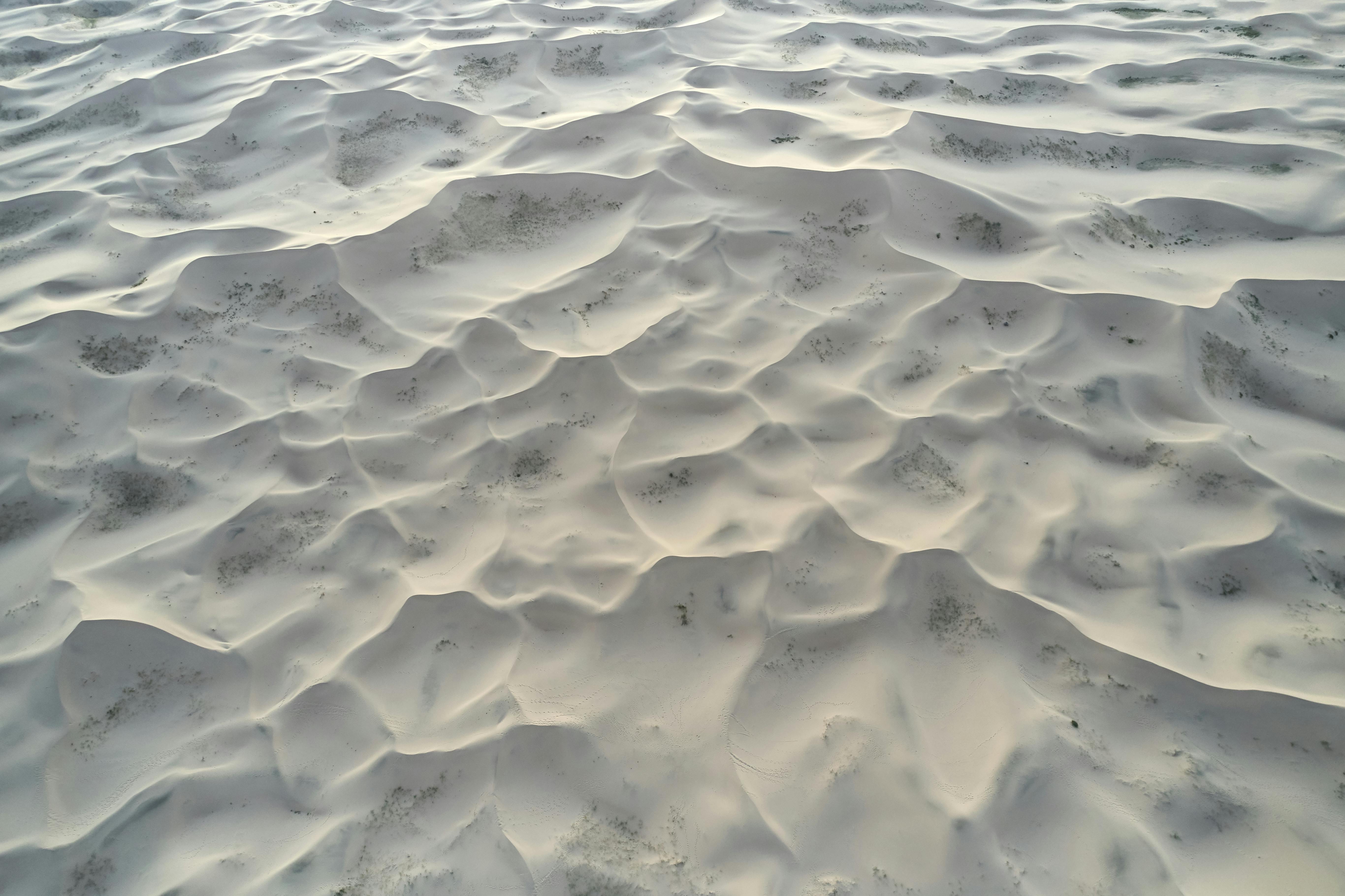 Wavy sandy surface in desert in daylight · Free Stock Photo