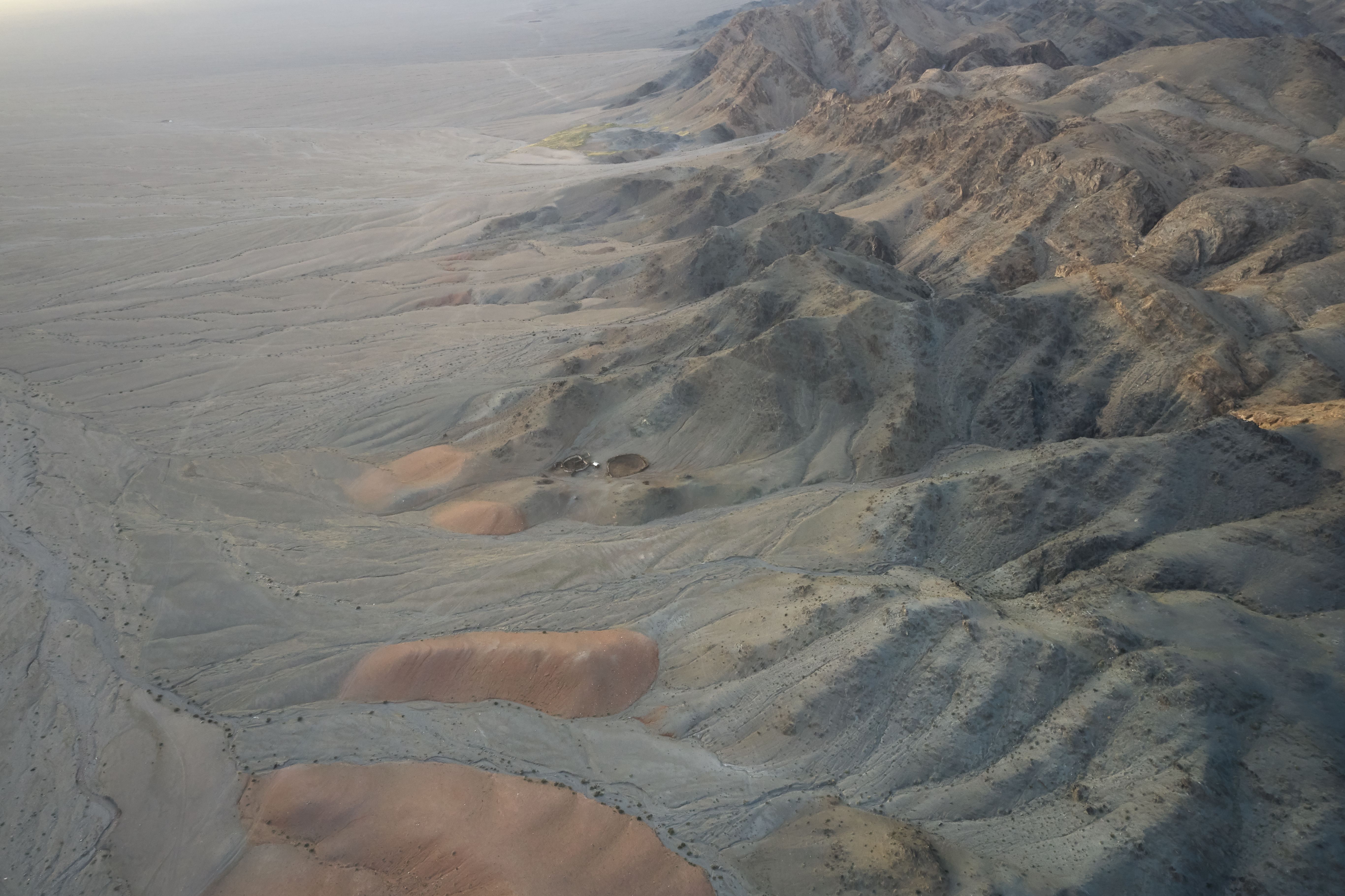 Sand desert with curved surface in afternoon · Free Stock Photo