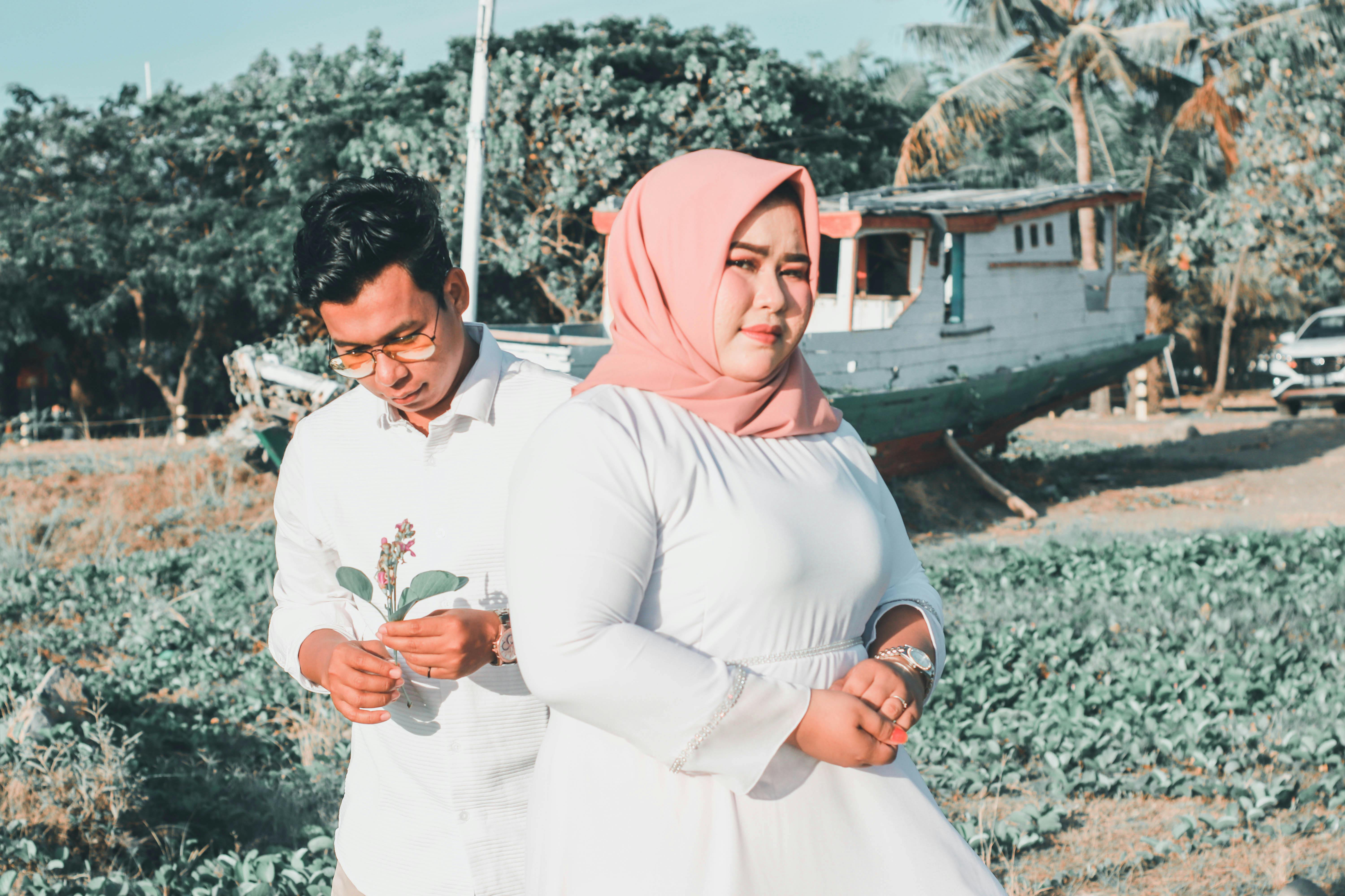 Muslim Couple Standing on a Field and Smiling · Free Stock Photo