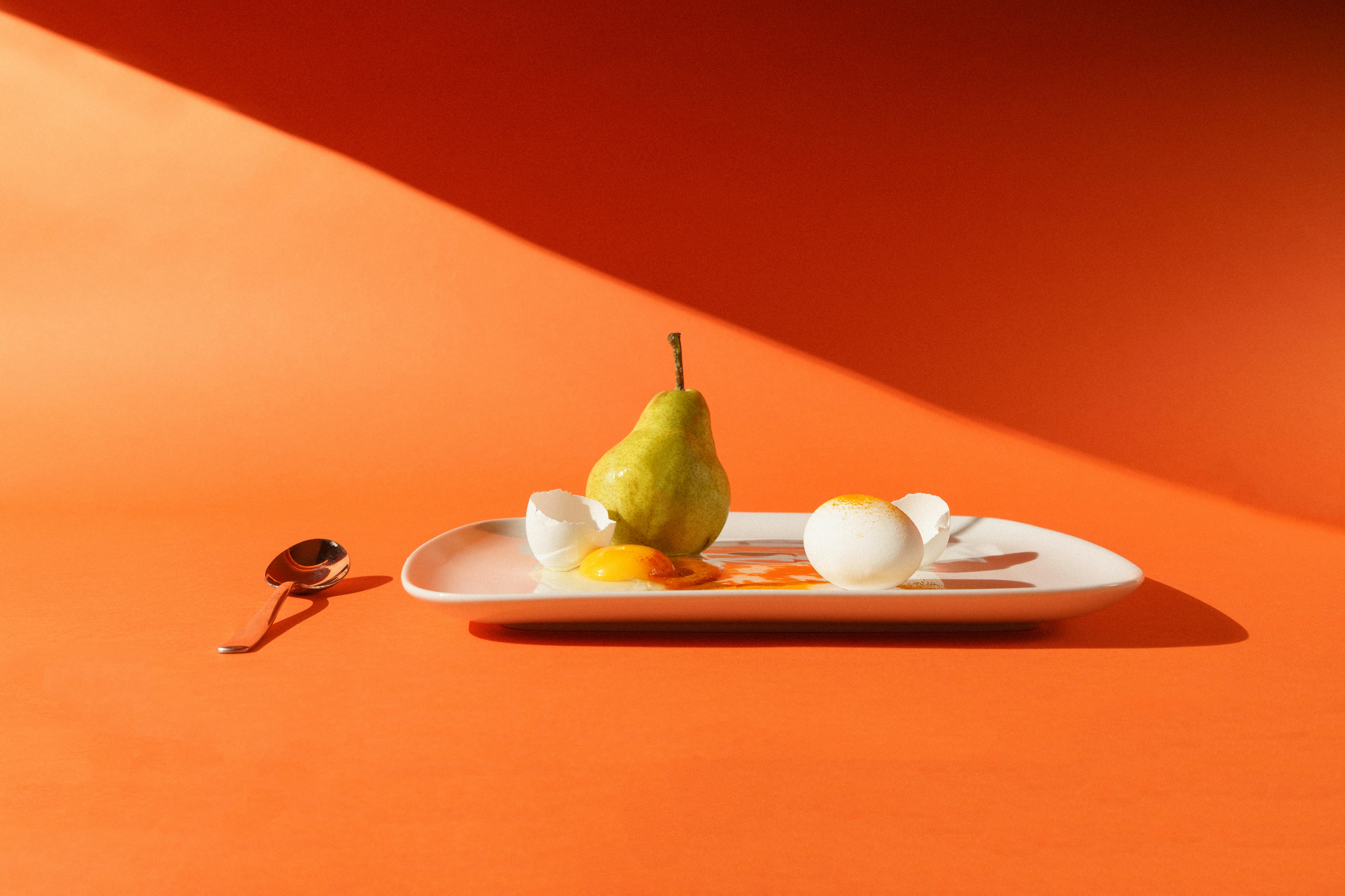Photo of a Pear and Eggs on a Plate · Free Stock Photo
