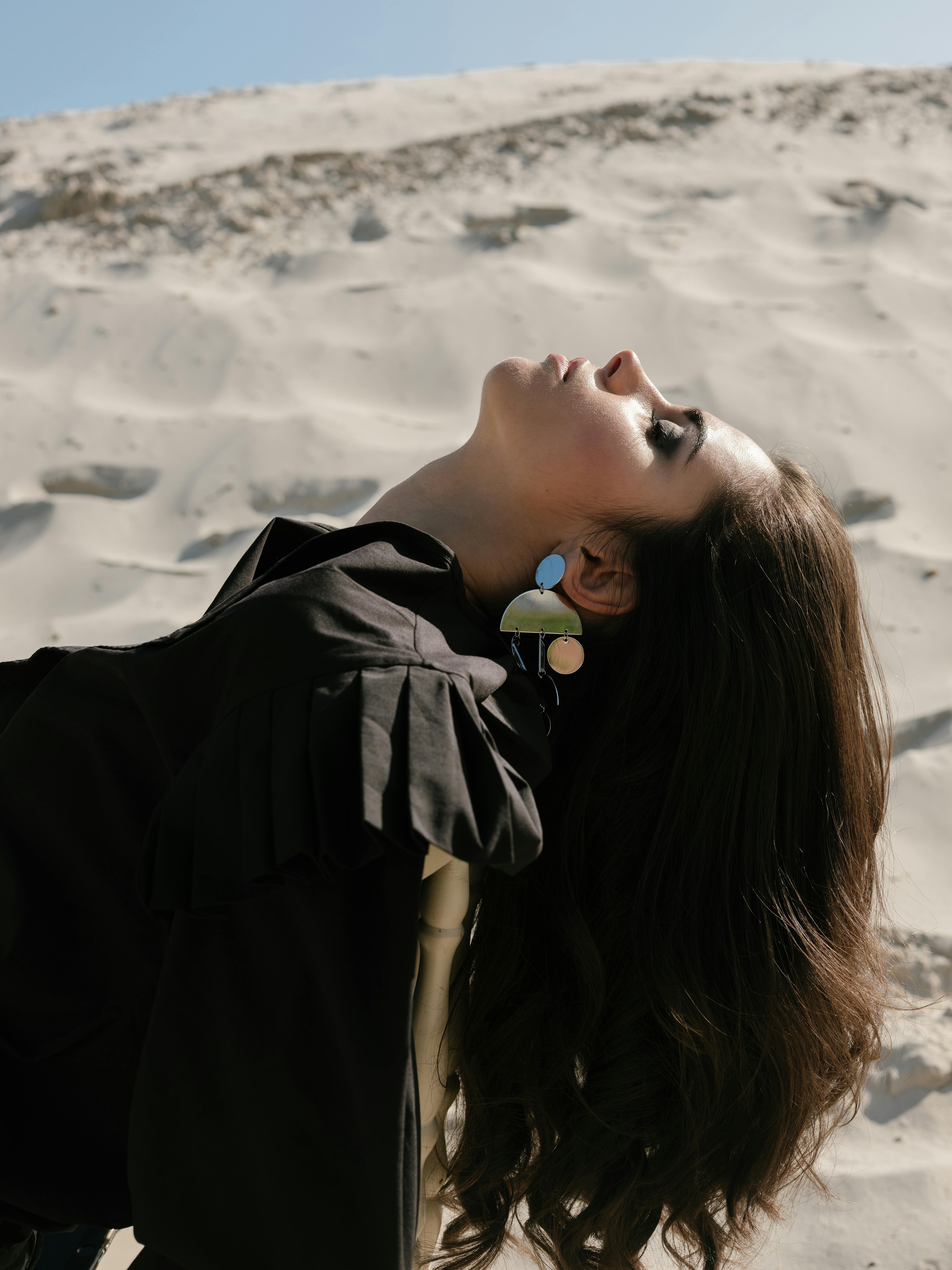 Elegant model with makeup leaning back alluringly in sunlight · Free ...