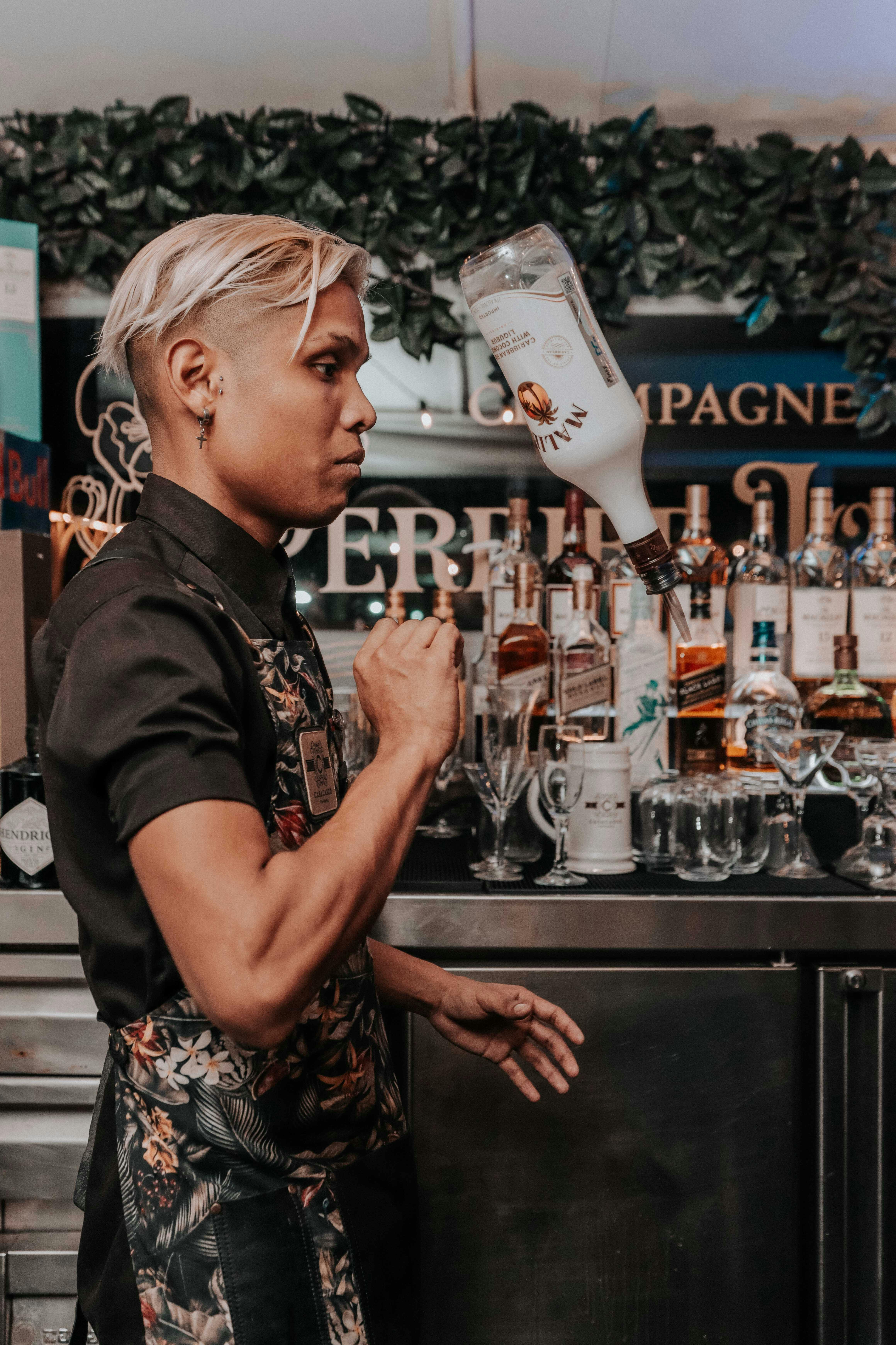 Assortment of syrups and alcohol on bar counter · Free Stock Photo