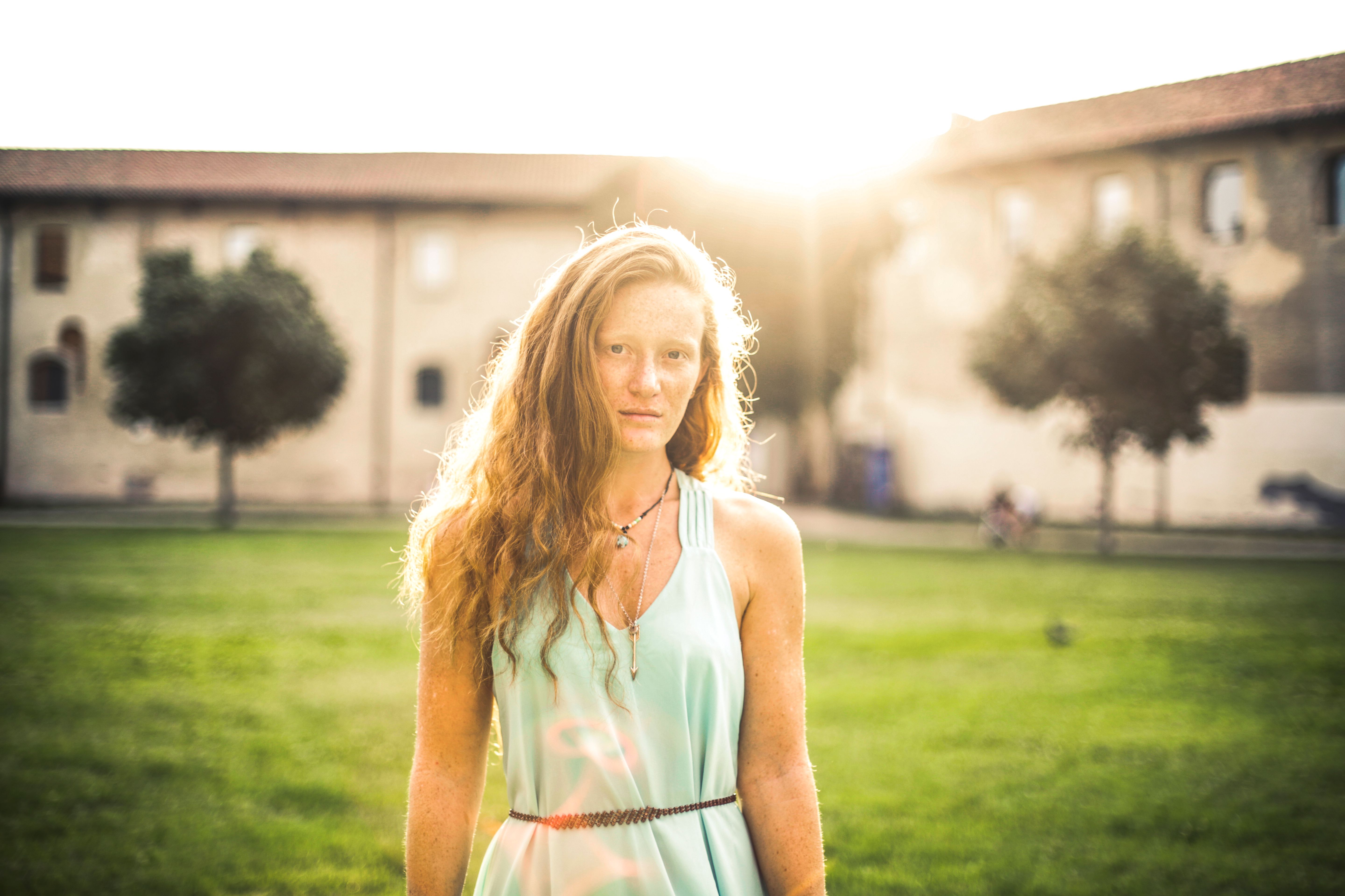 Beautiful woman with ginger hair in sunlight · Free Stock Photo