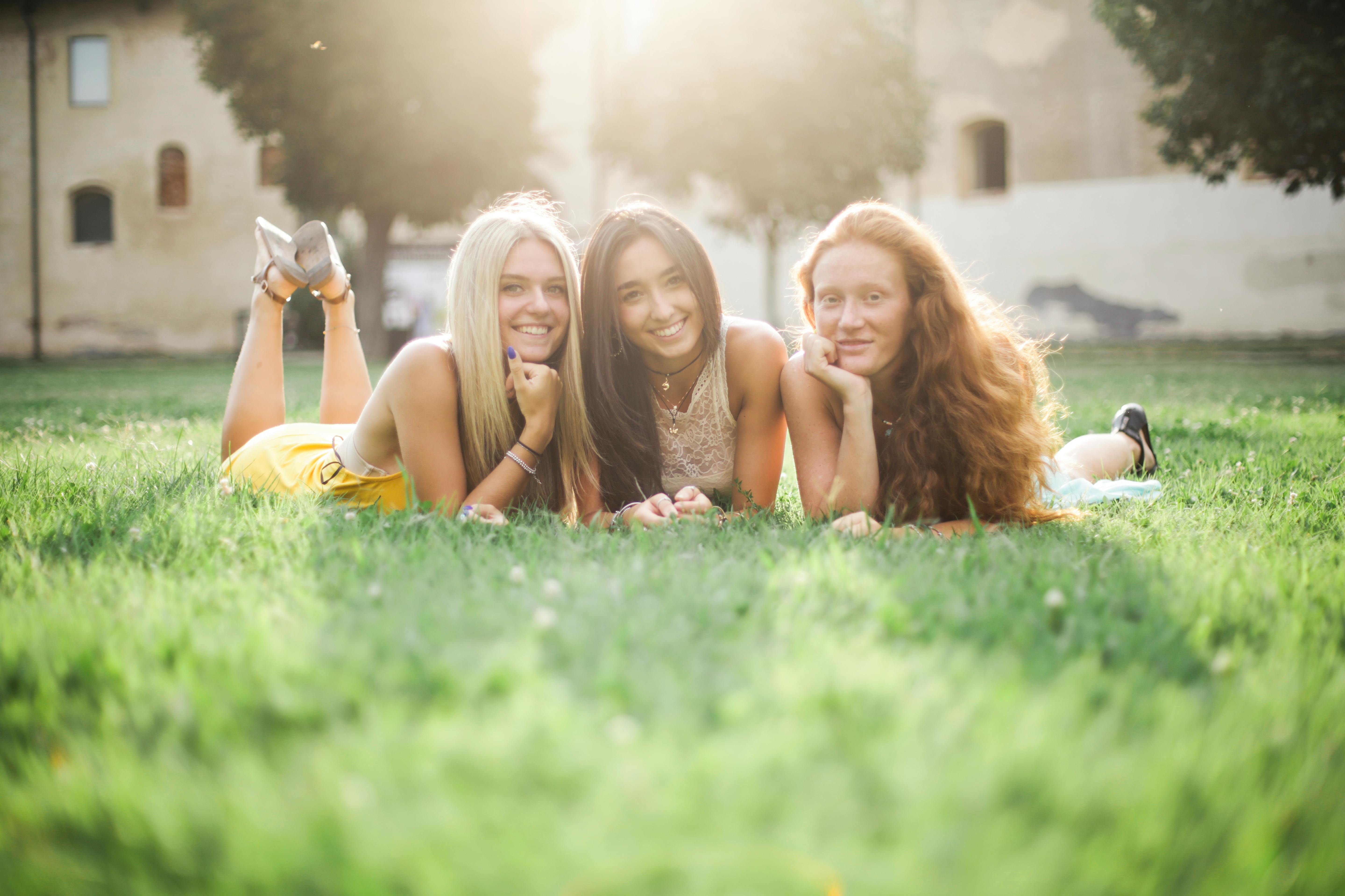 Happy women lounging in park · Free Stock Photo