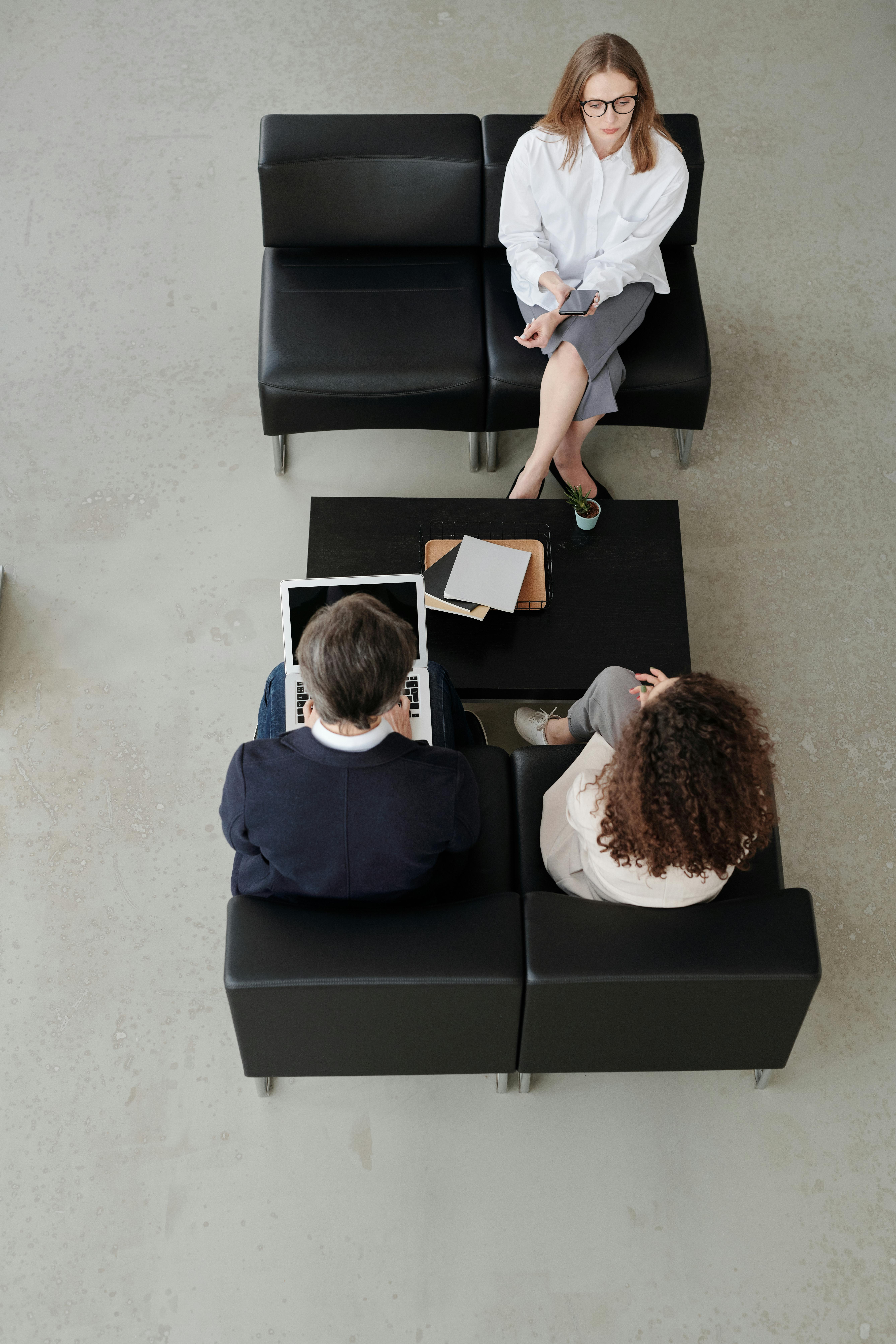 People Sitting on Black Couch · Free Stock Photo