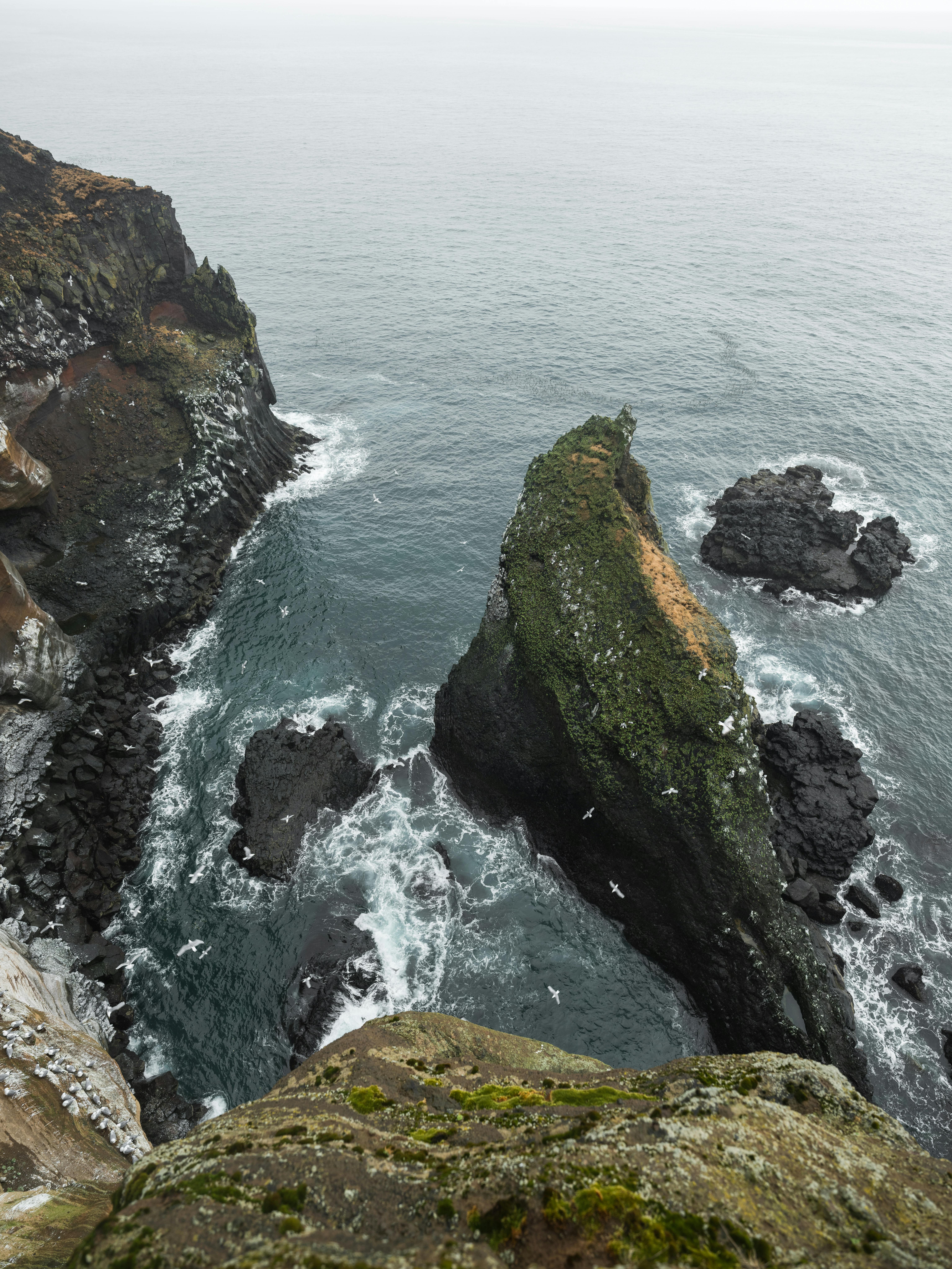 Majestic cliff with rocks in sea · Free Stock Photo