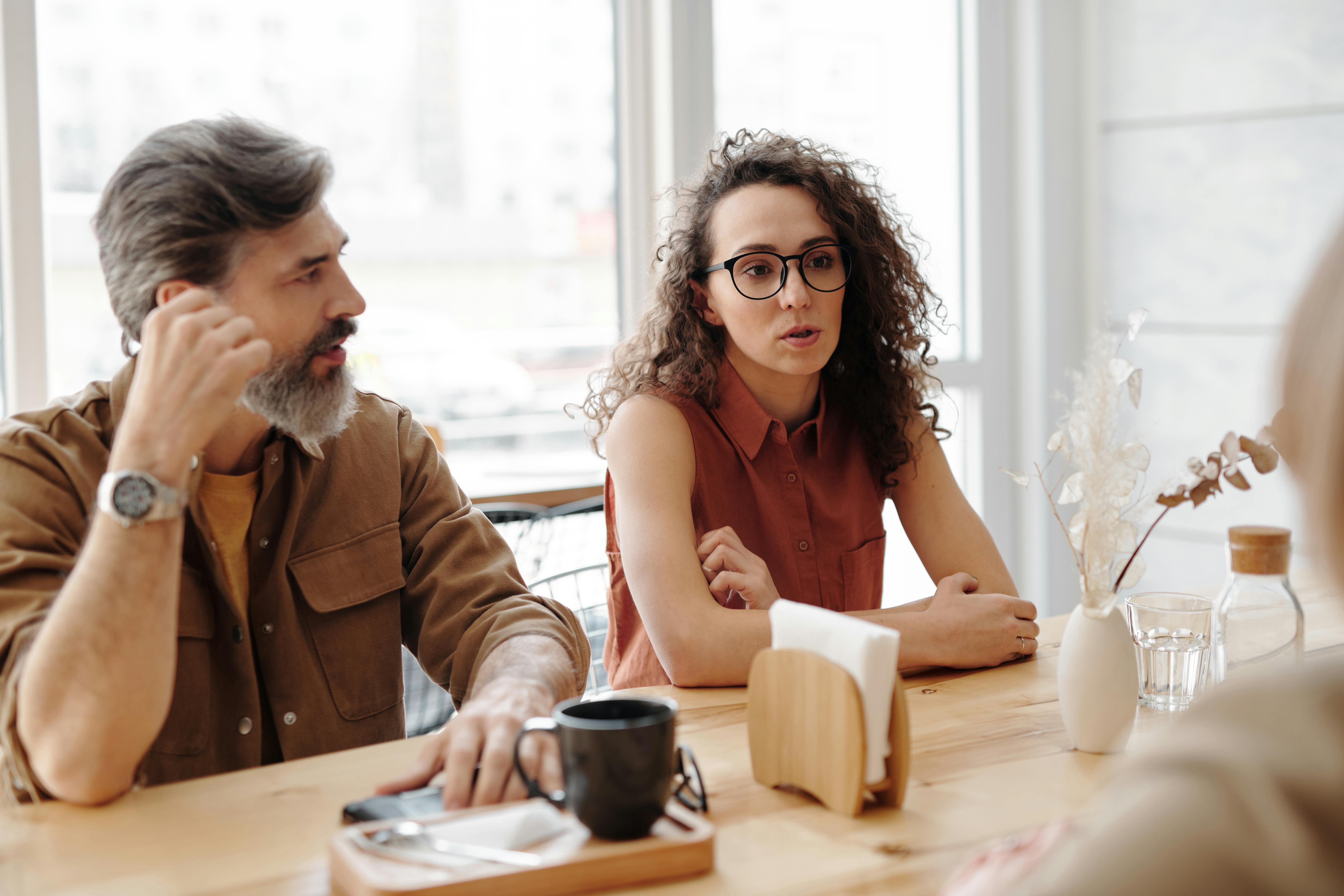 Two Friends Talking Inside the Cafe · Free Stock Photo