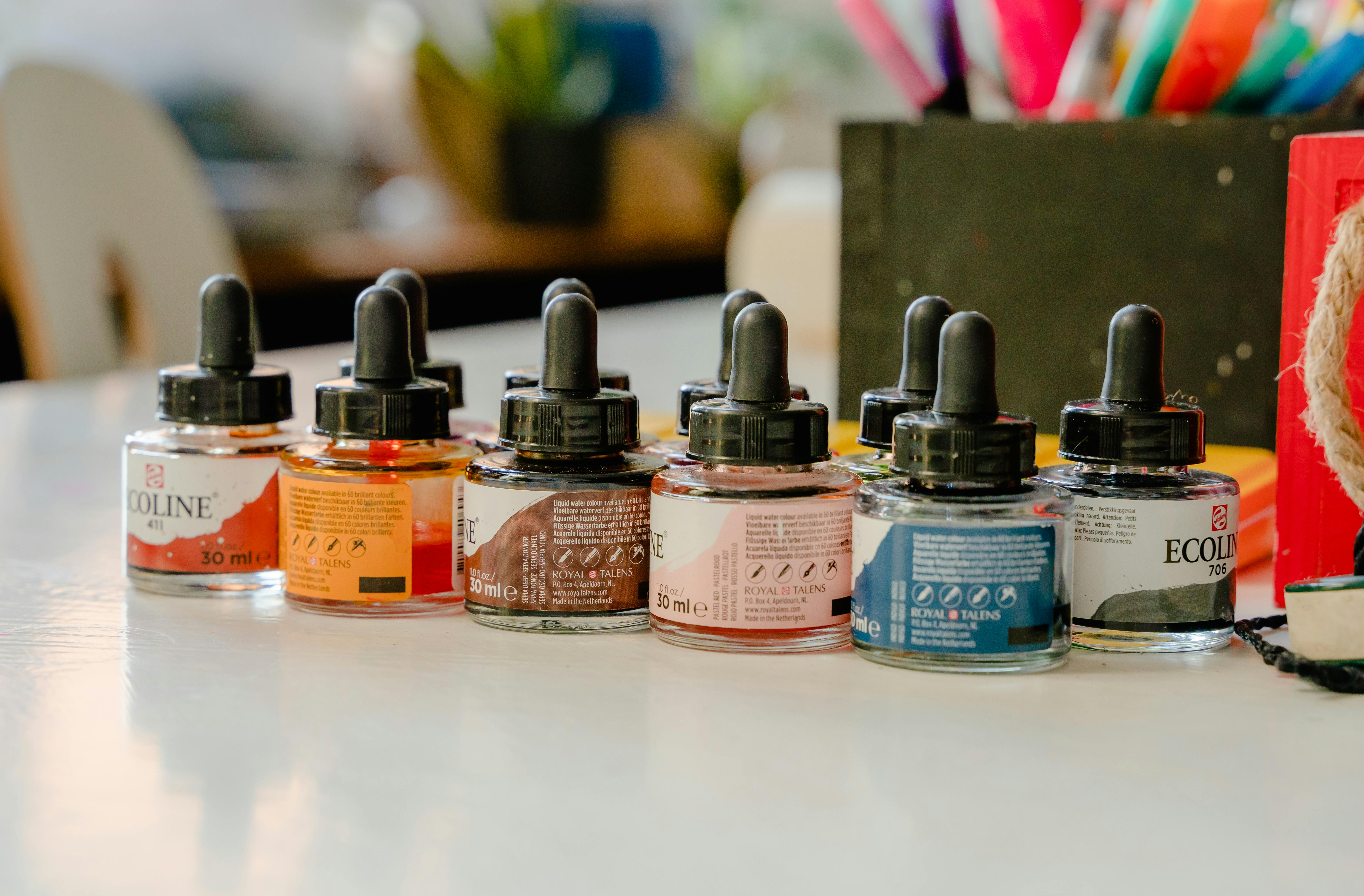 Assorted Colors of Ink Bottles on White Table · Free Stock Photo