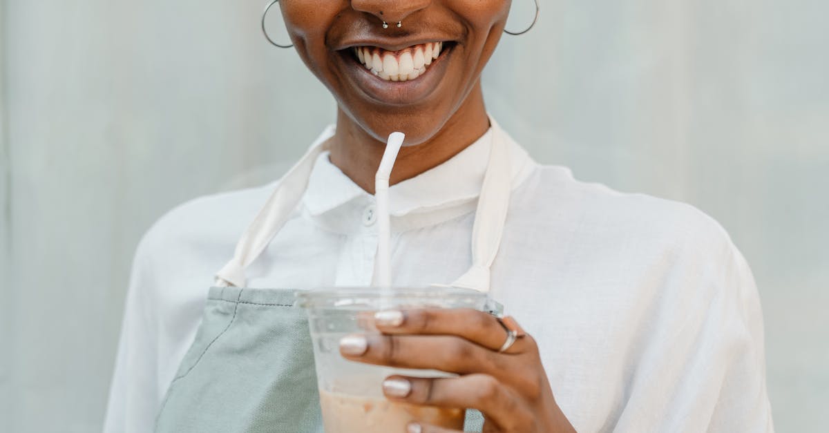 Photo of Woman Smiling While Holding Plastic Cup With Coffee · Free ... Photo of Woman Smiling While Holding Plastic Cup With Coffee · Free ...