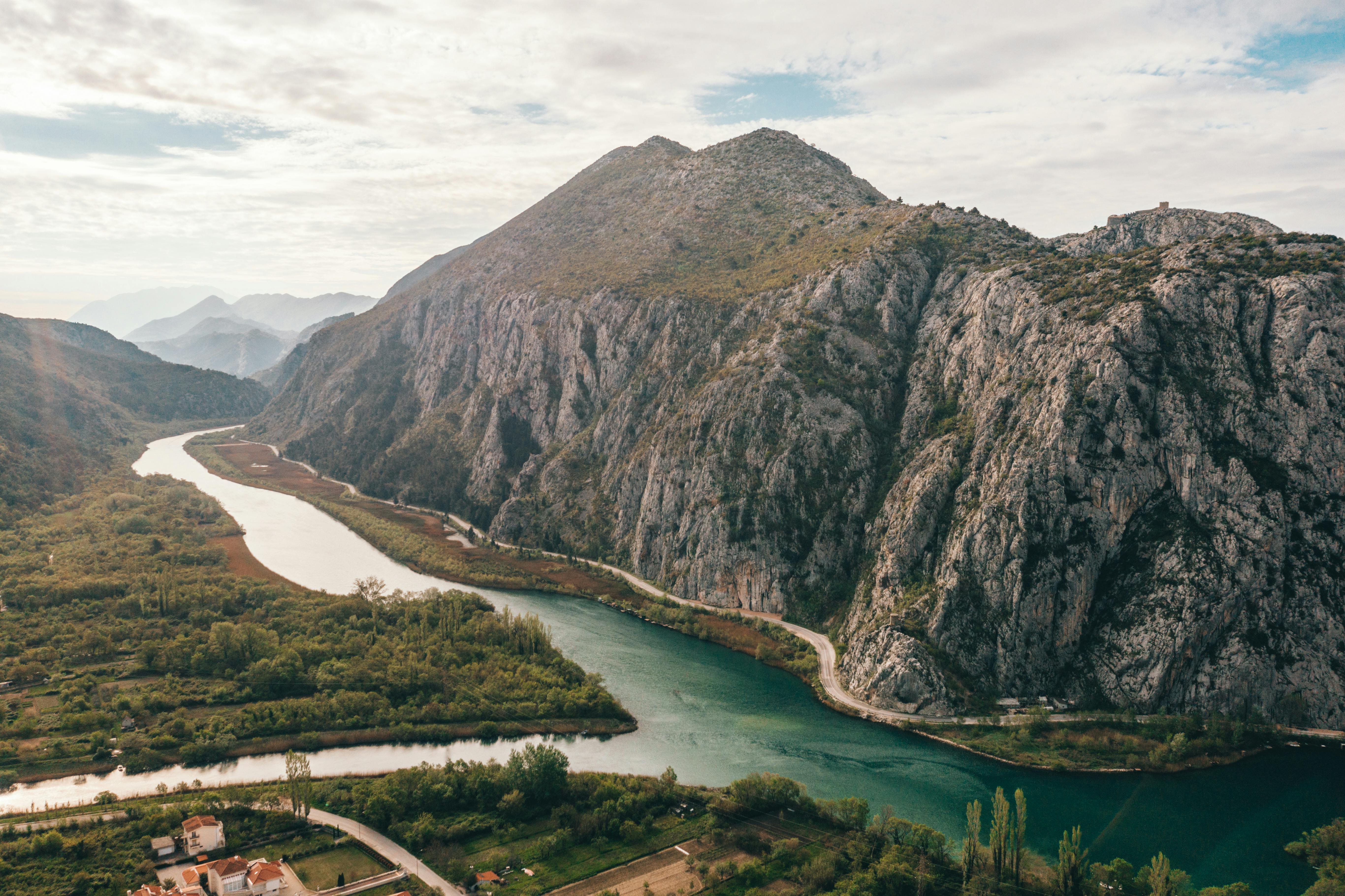 Mountainous terrain with river and village · Free Stock Photo