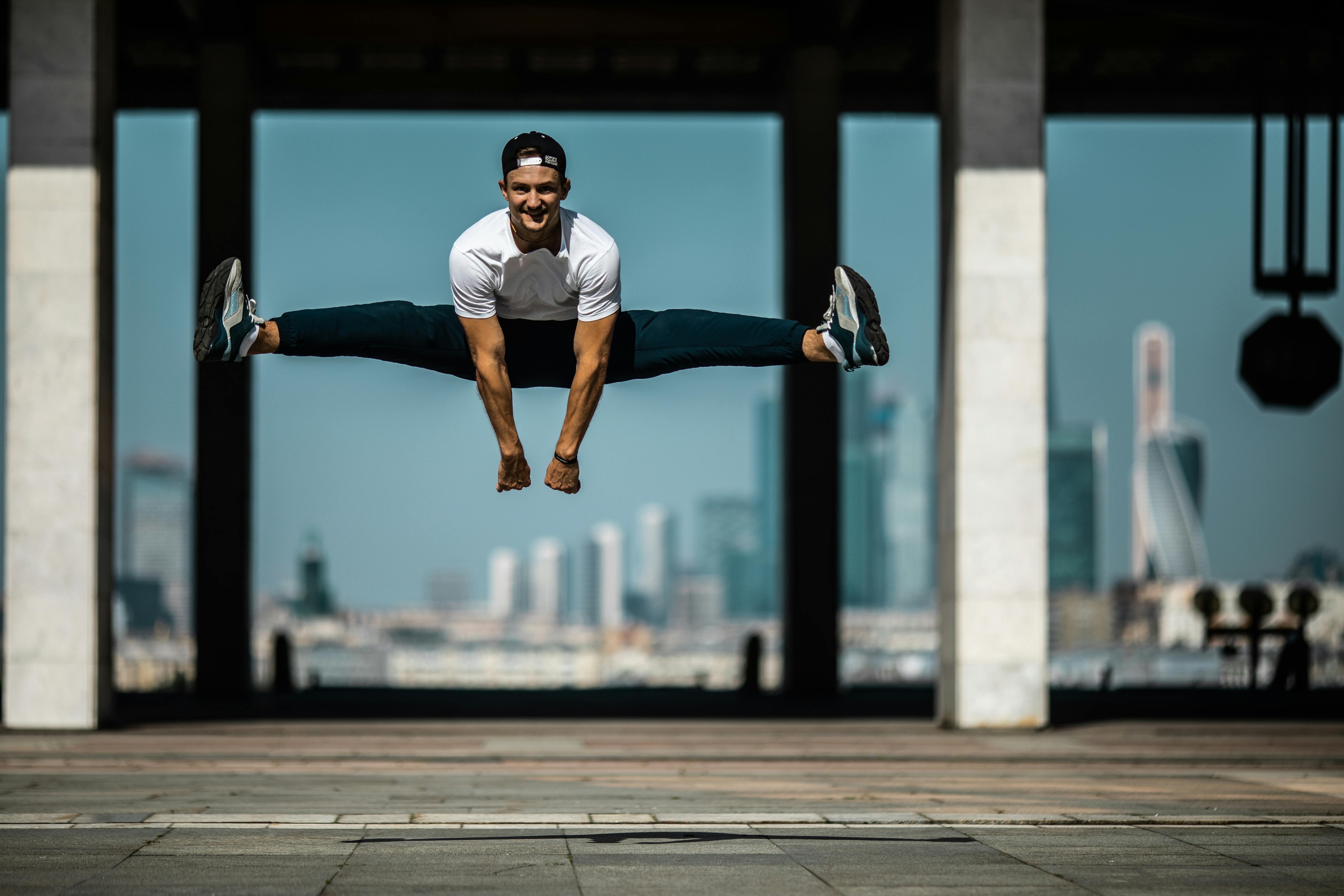 A Man Doing a Leg Split in Mid Air · Free Stock Photo