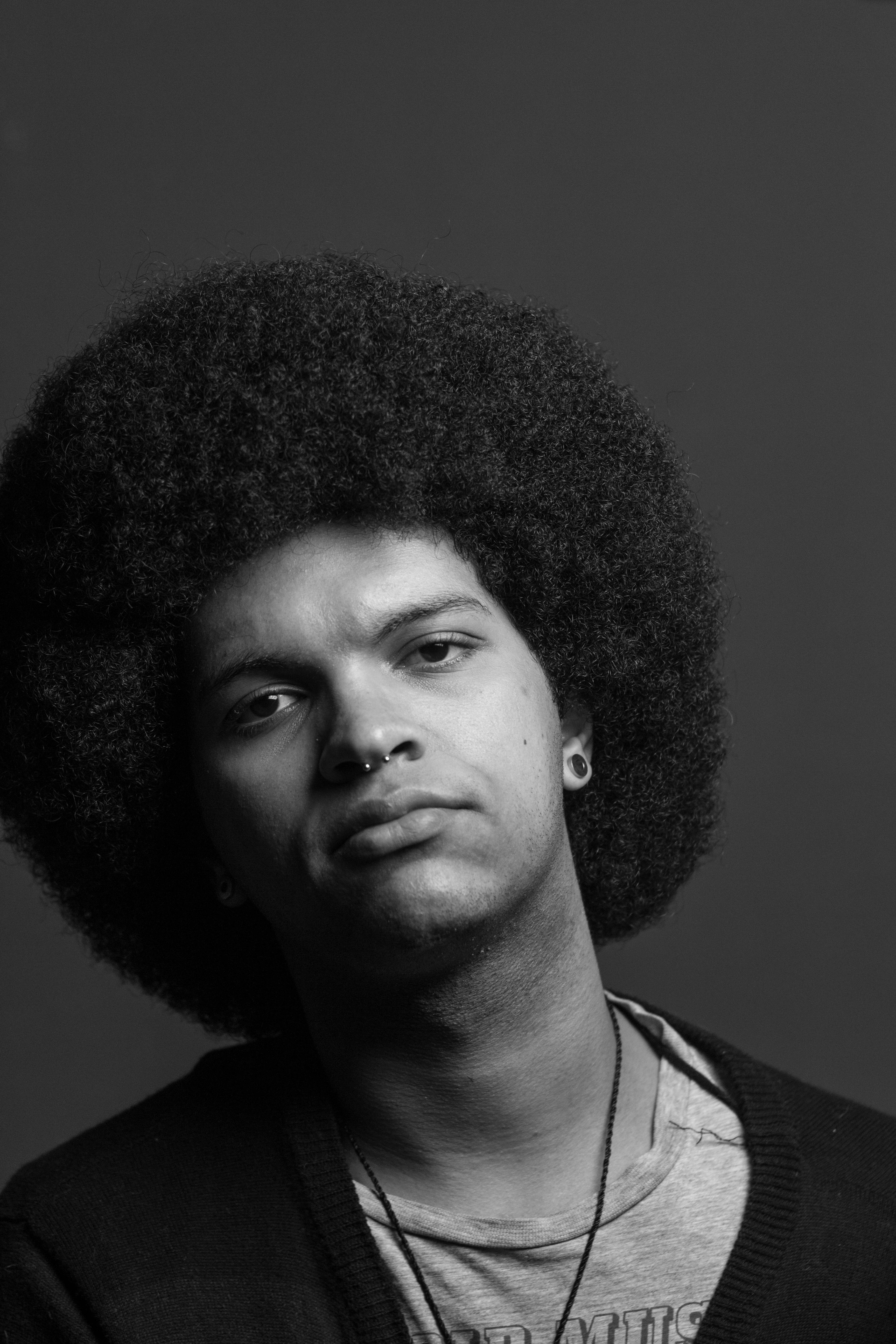 Man With Afro Hair Holding Delicate Flower · Free Stock Photo