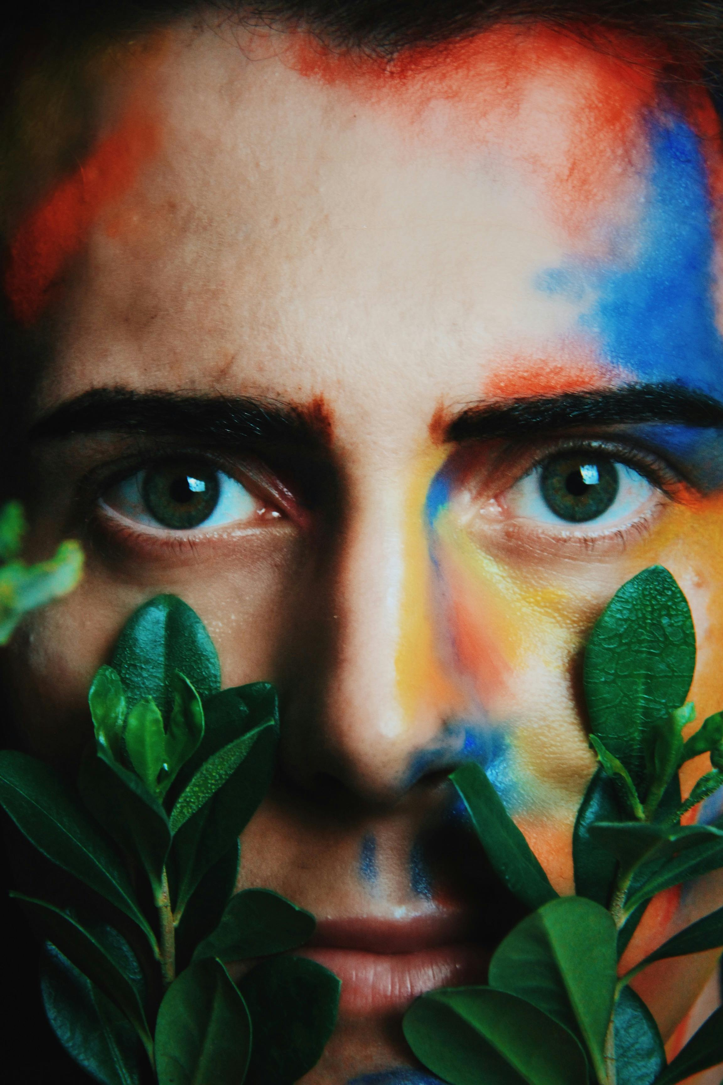 Artistic male model with colorful paints on face in studio · Free Stock ...