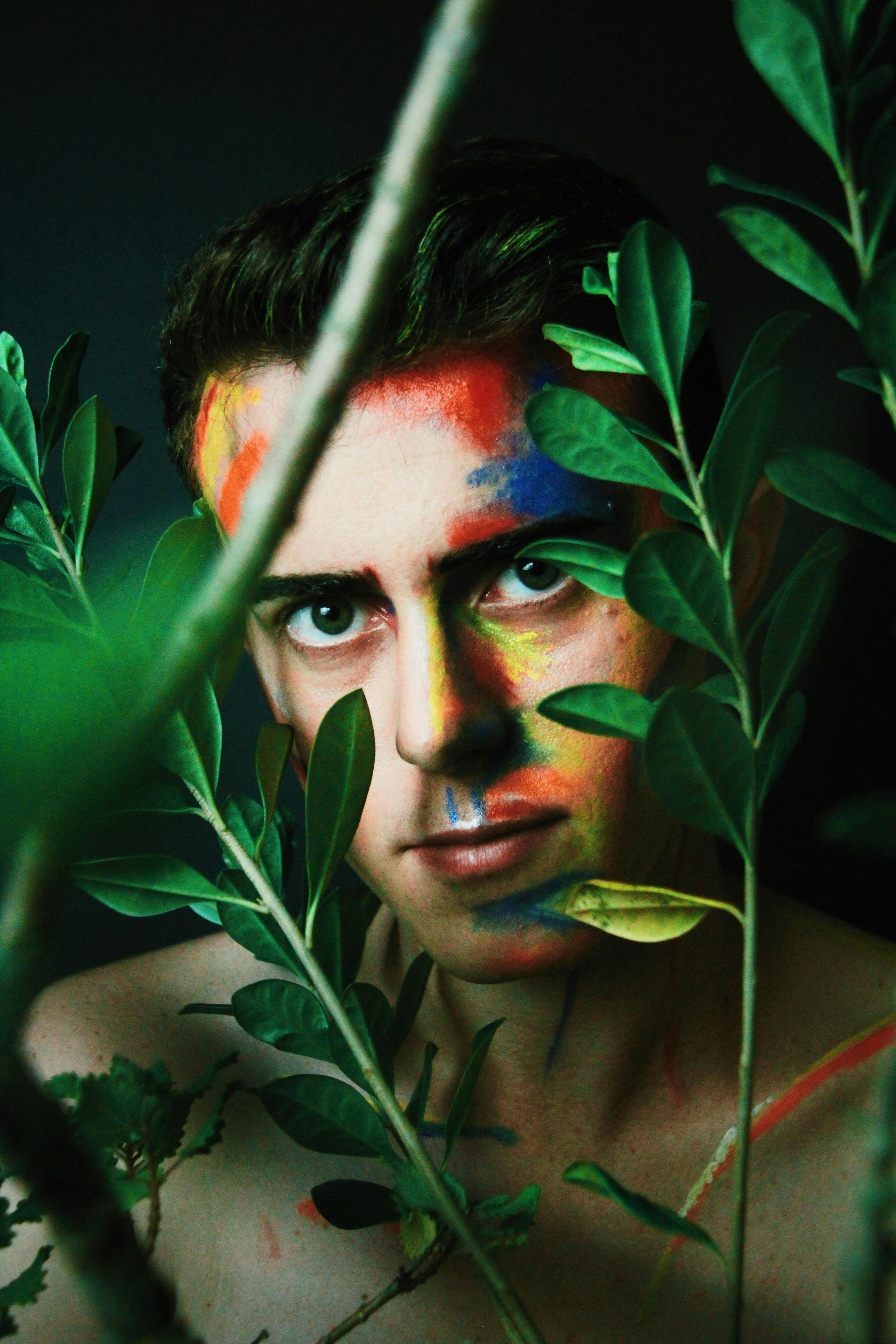 Content man model with multicolored paints on face and plants · Free ...