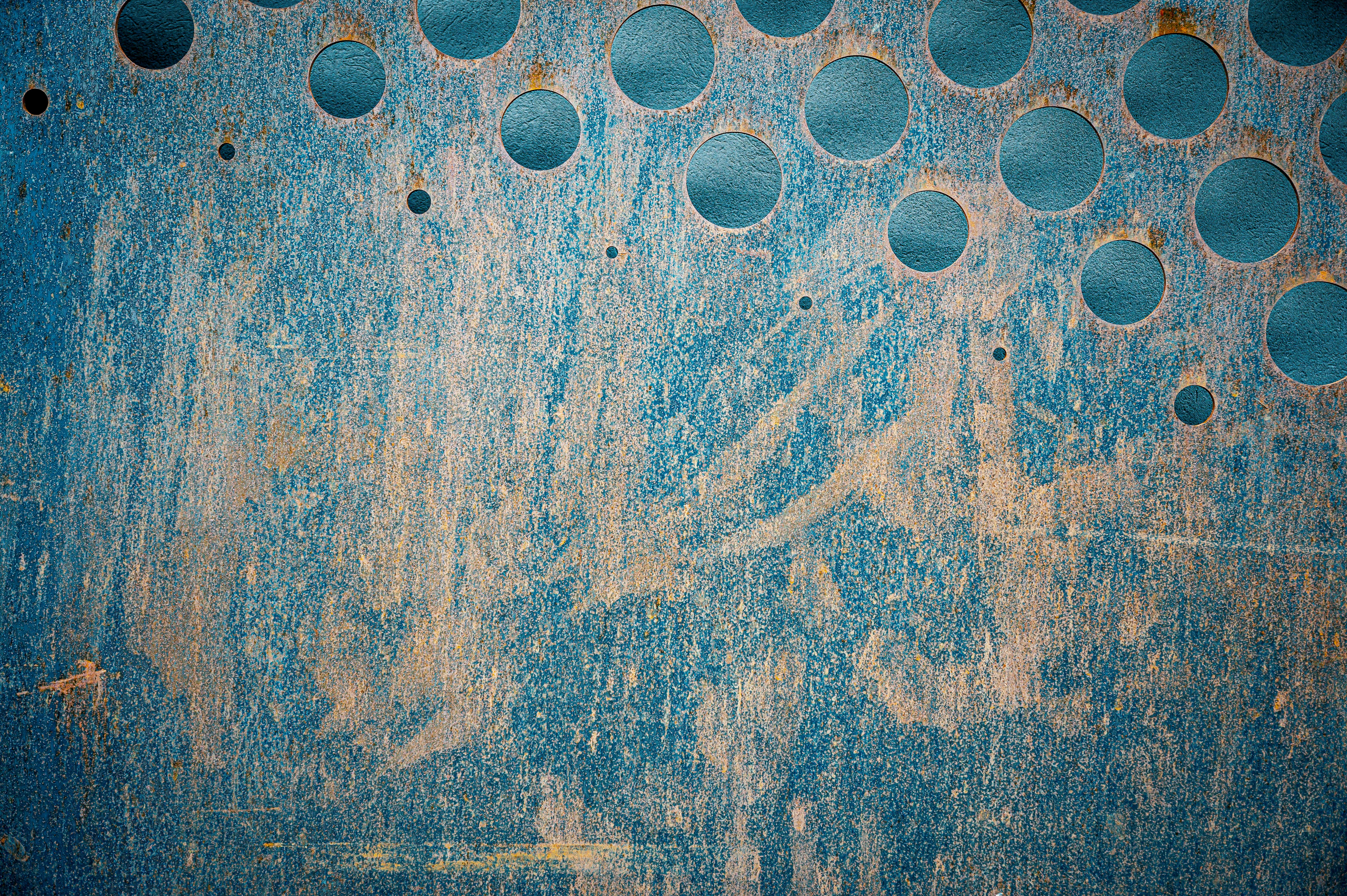 Abstract background of grunge wall with round holes · Free Stock Photo