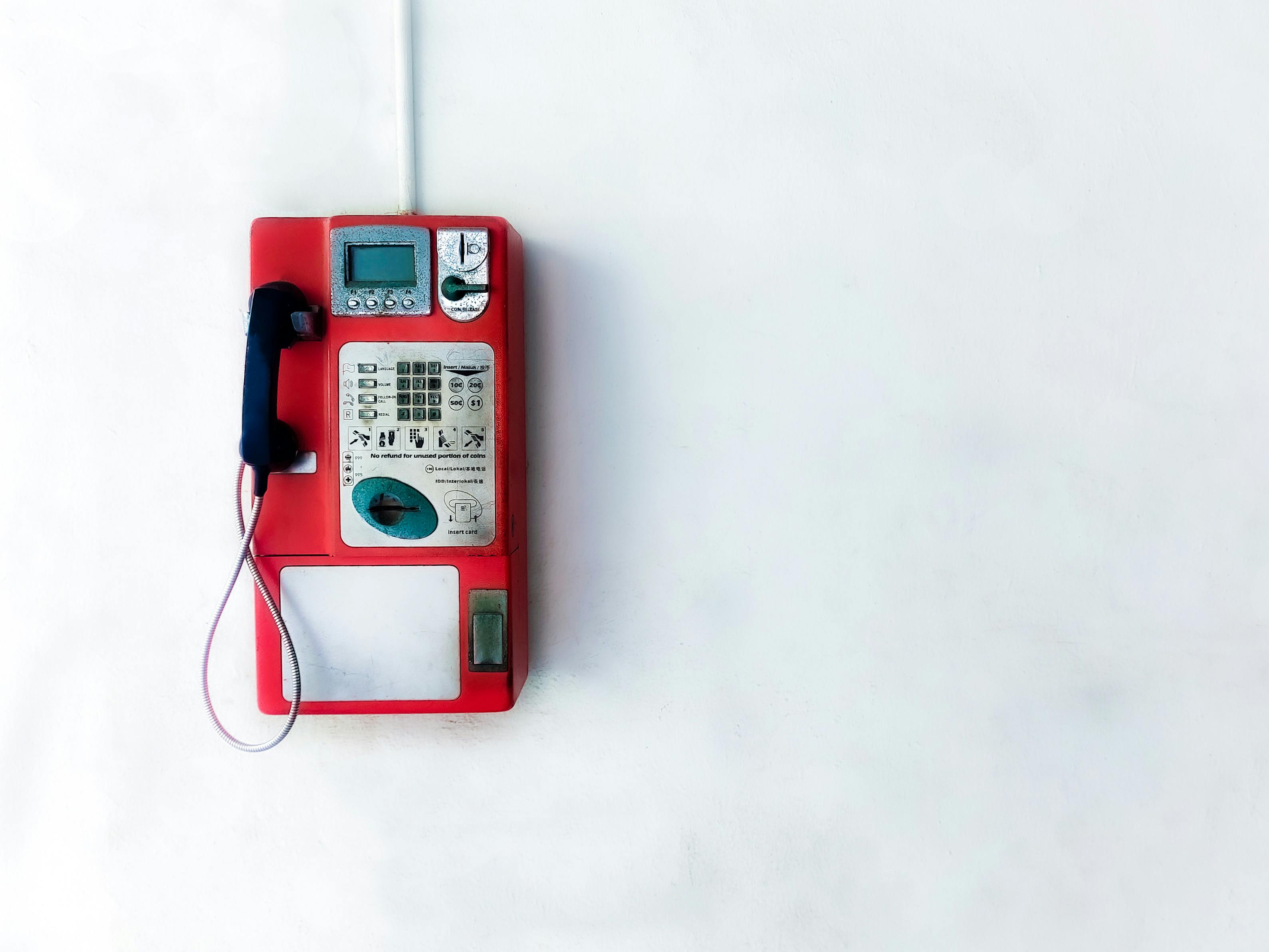 Old metal public payphone hanging on shabby wall · Free Stock Photo