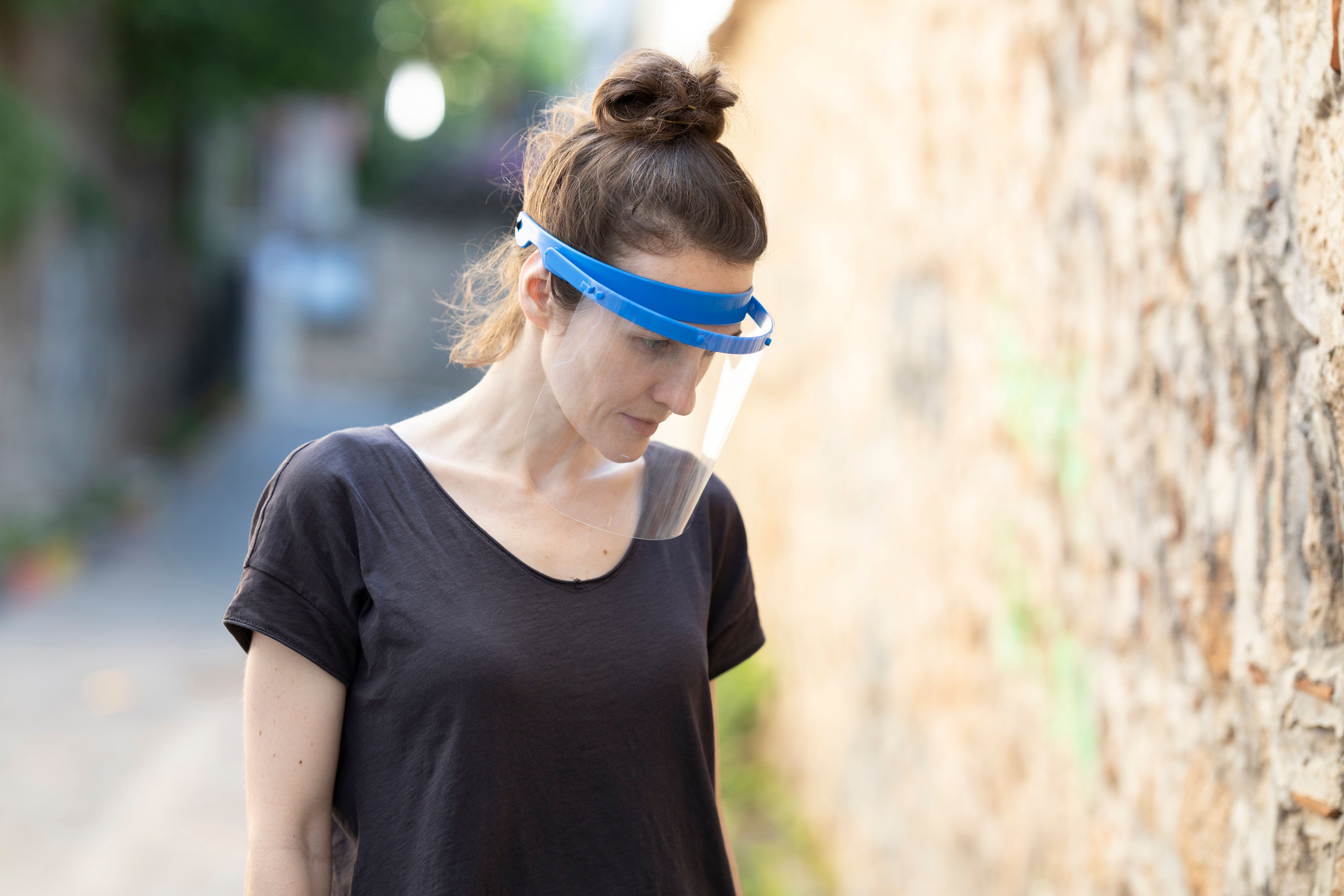 Woman in Tight Black Dress Shielding Face from Camera · Free Stock Photo