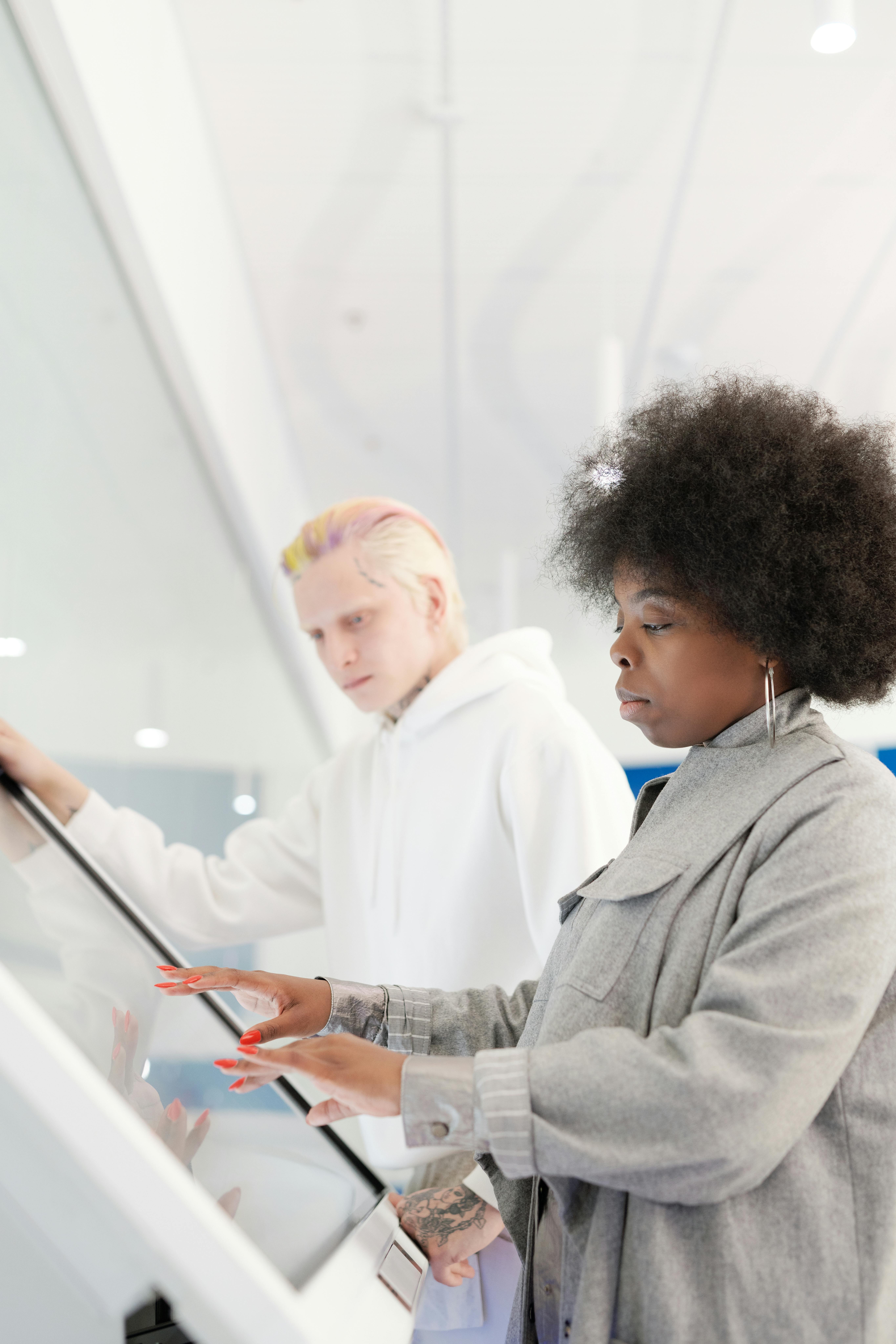 Side View of a Woman using a Touchscreen Device · Free Stock Photo