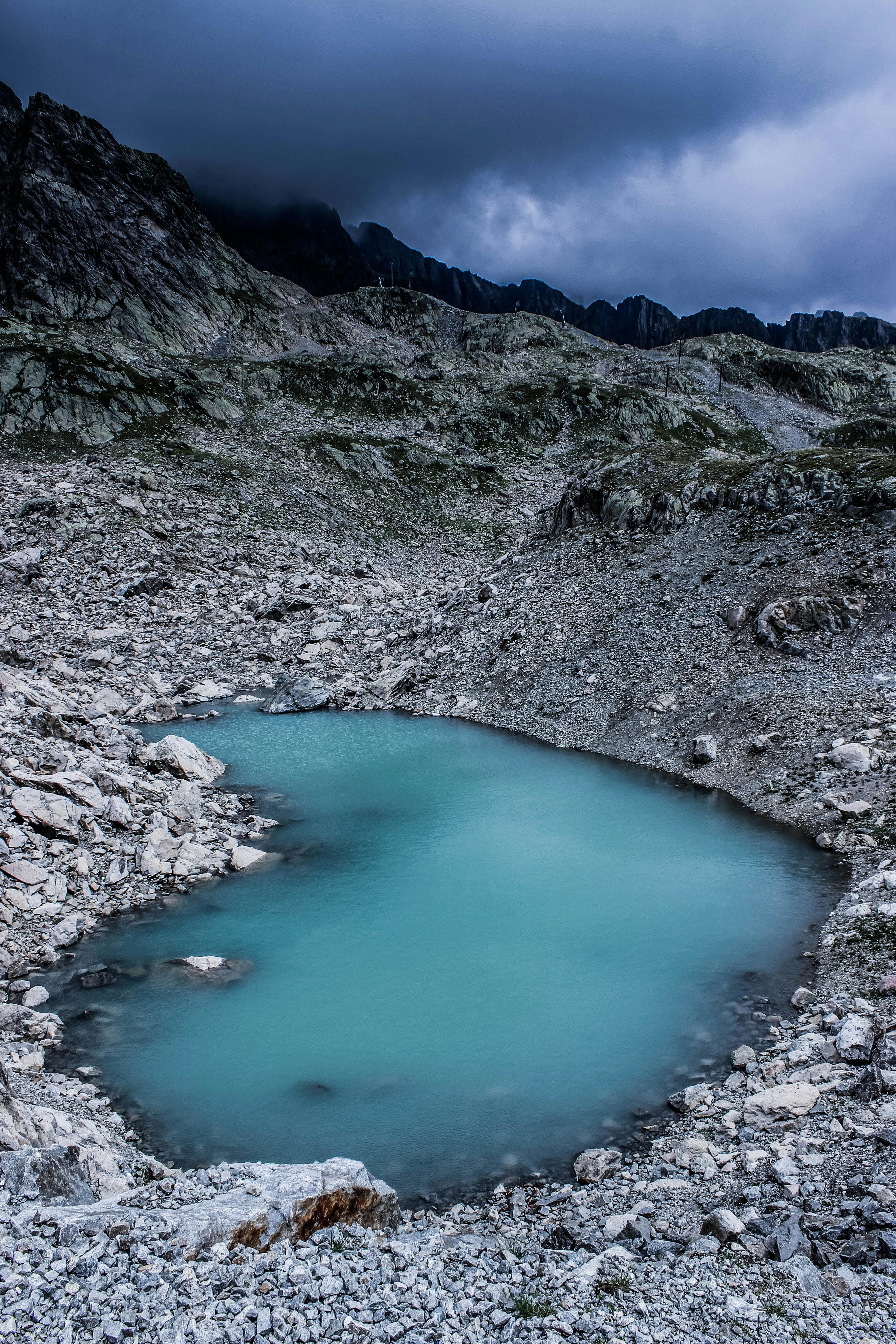 Cold small lake puddle of water in mountainous terrain · Free Stock Photo