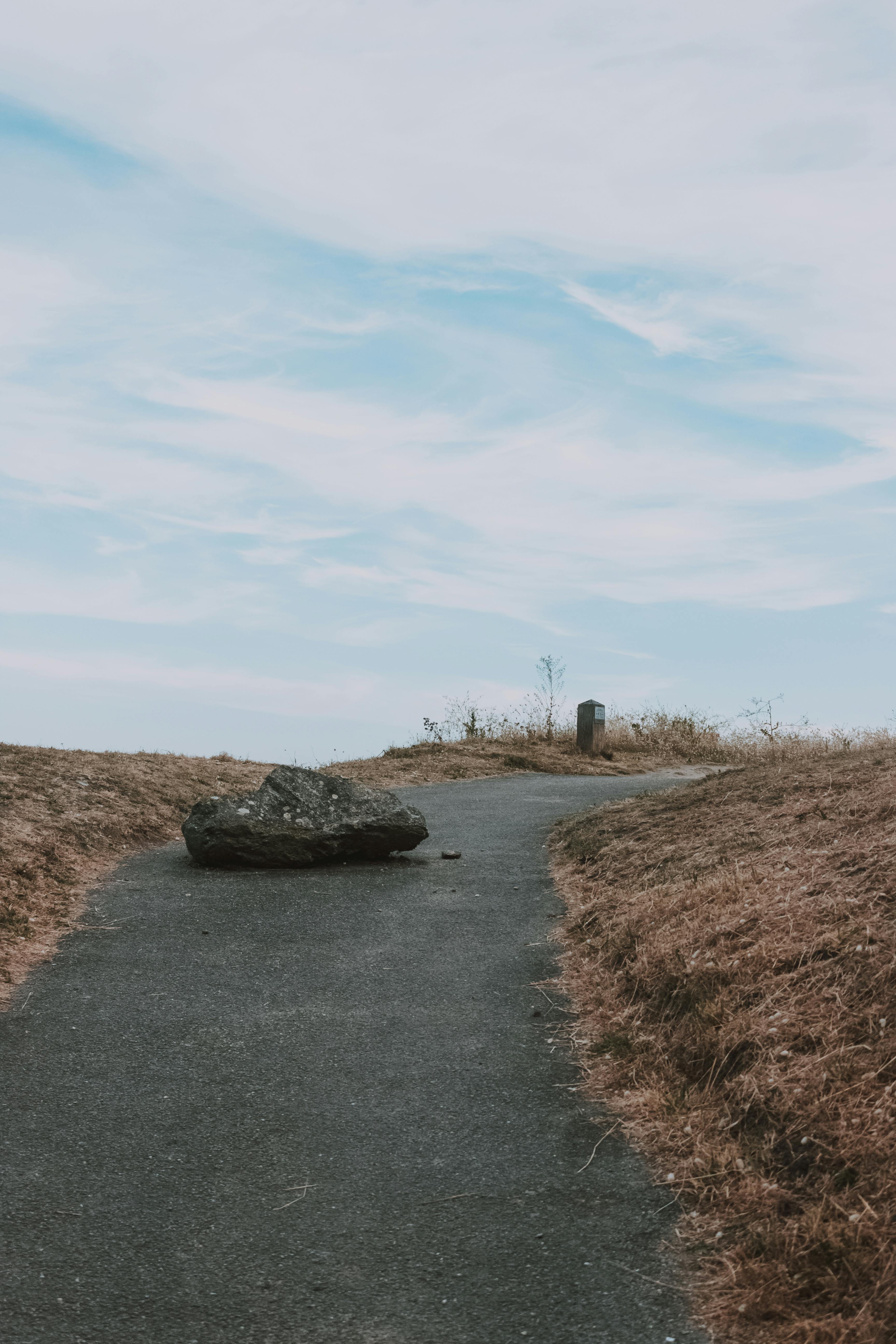 Empty pathway with rough stone under cloudy sky · Free Stock Photo