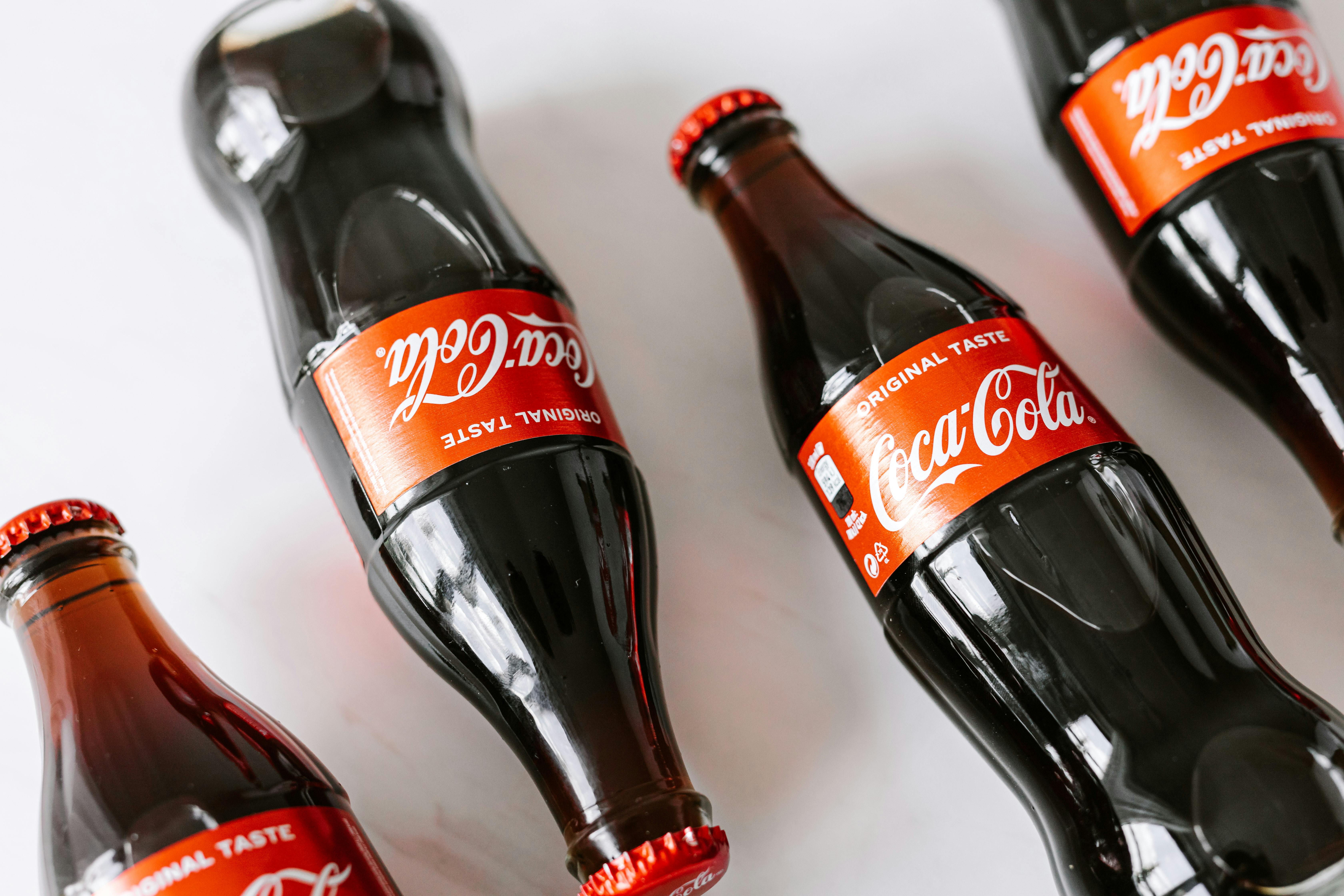 Bottles of soft coke drink on white background · Free Stock Photo