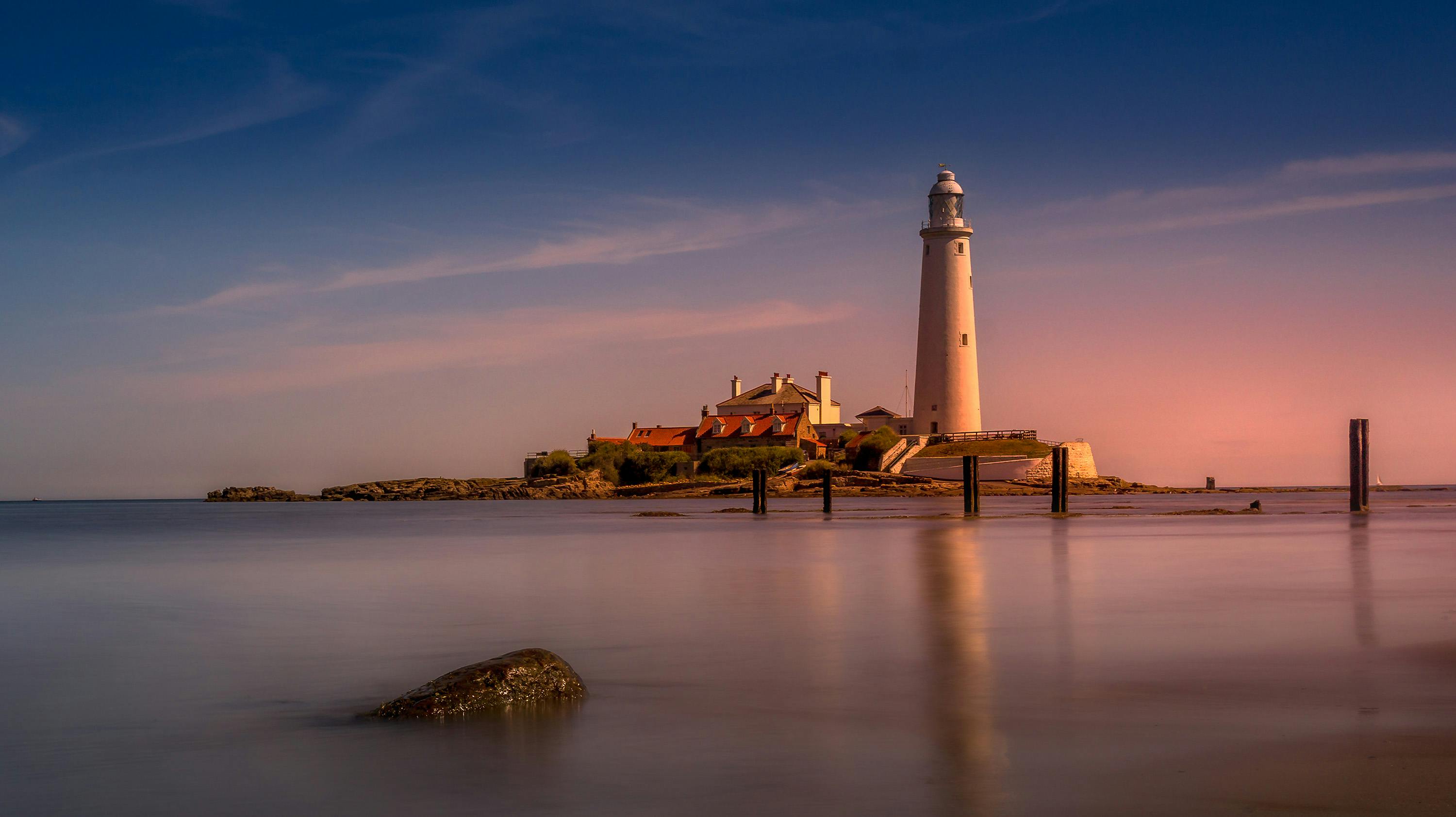 Lighthouse located near calm sea water · Free Stock Photo