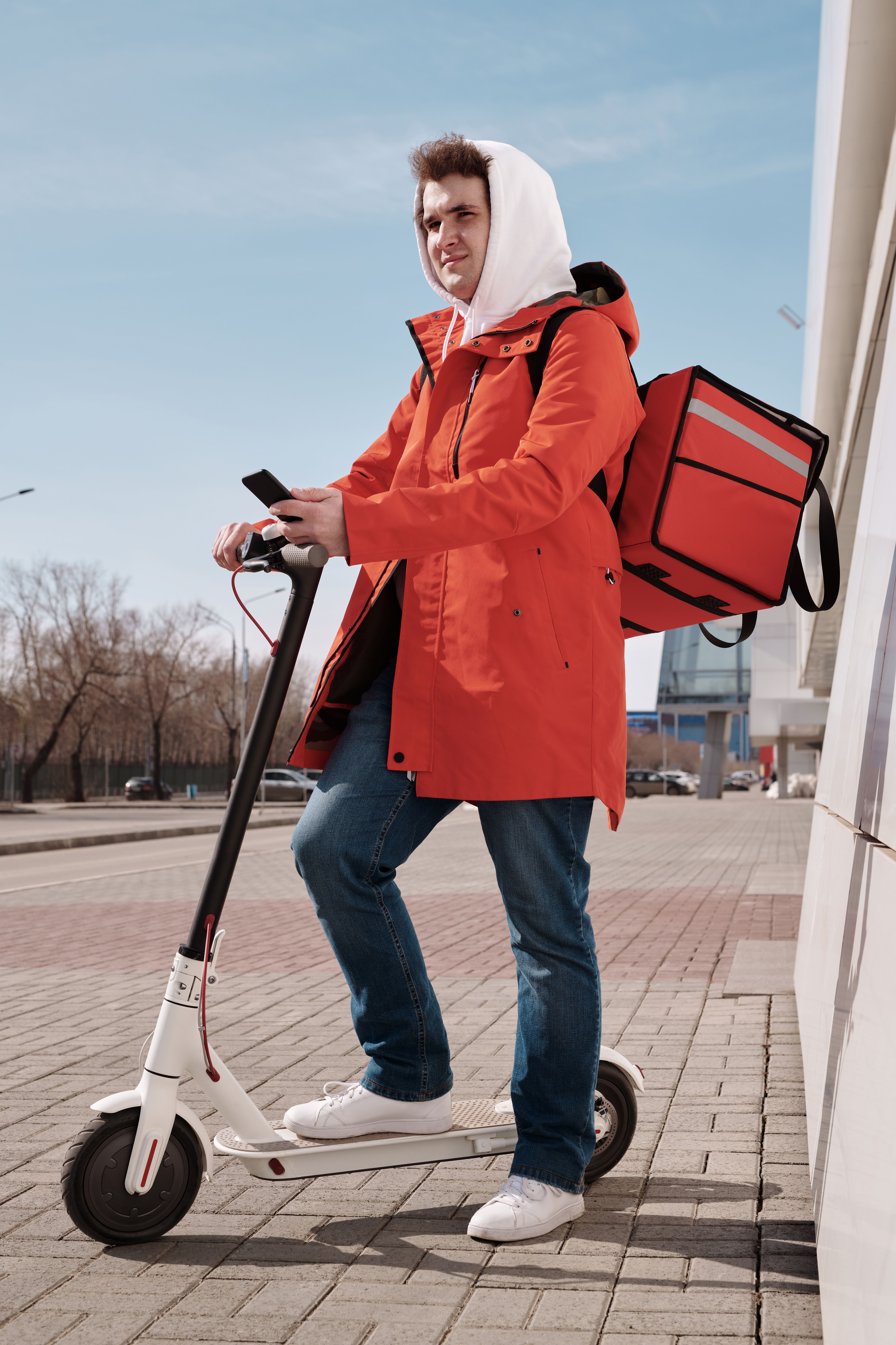 Man Carrying Thermal Bag Wearing Orange Jacket · Free Stock Photo