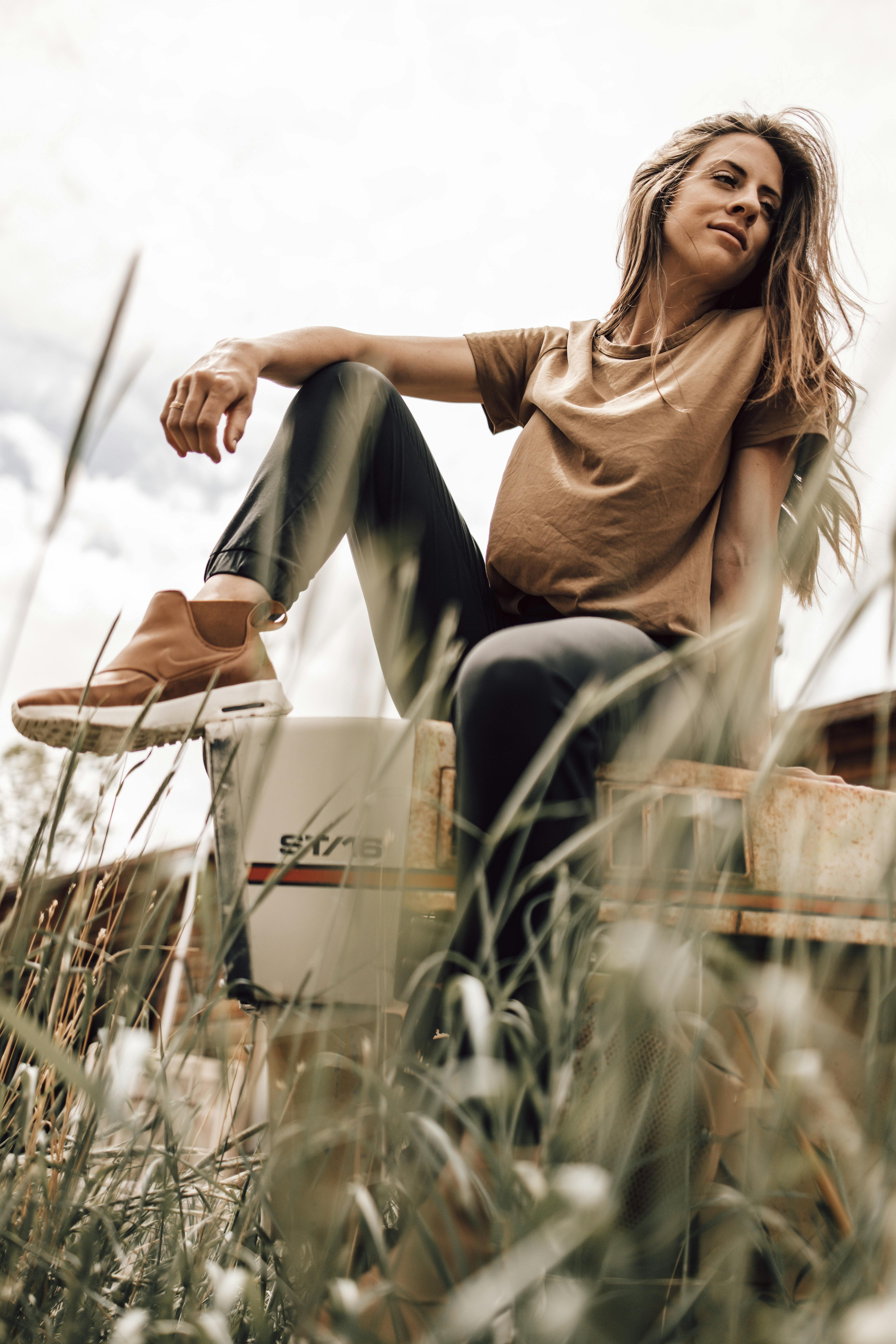 Blonde Model Sitting on Meadow · Free Stock Photo
