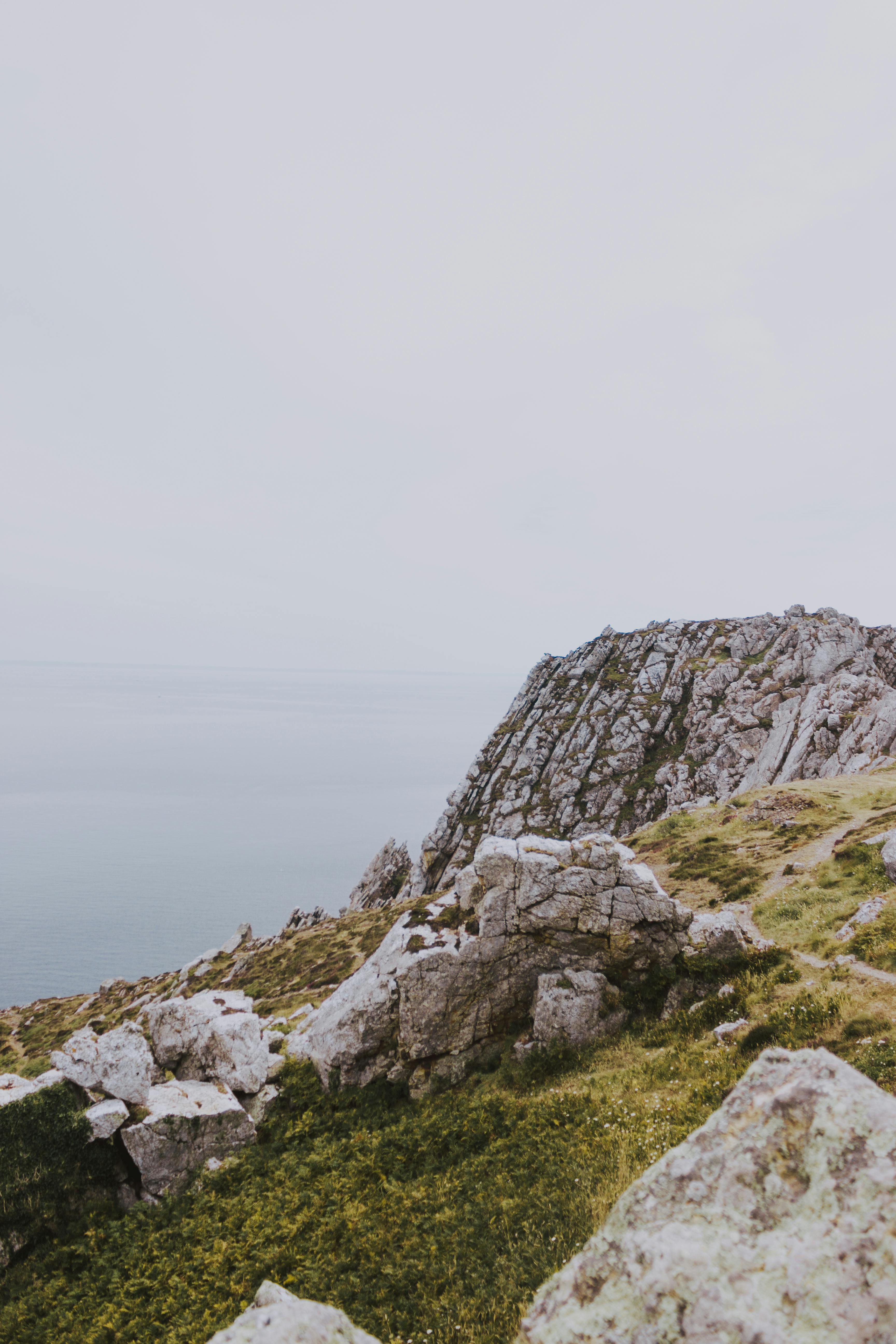 Cliff and mountain slope covered with grass · Free Stock Photo