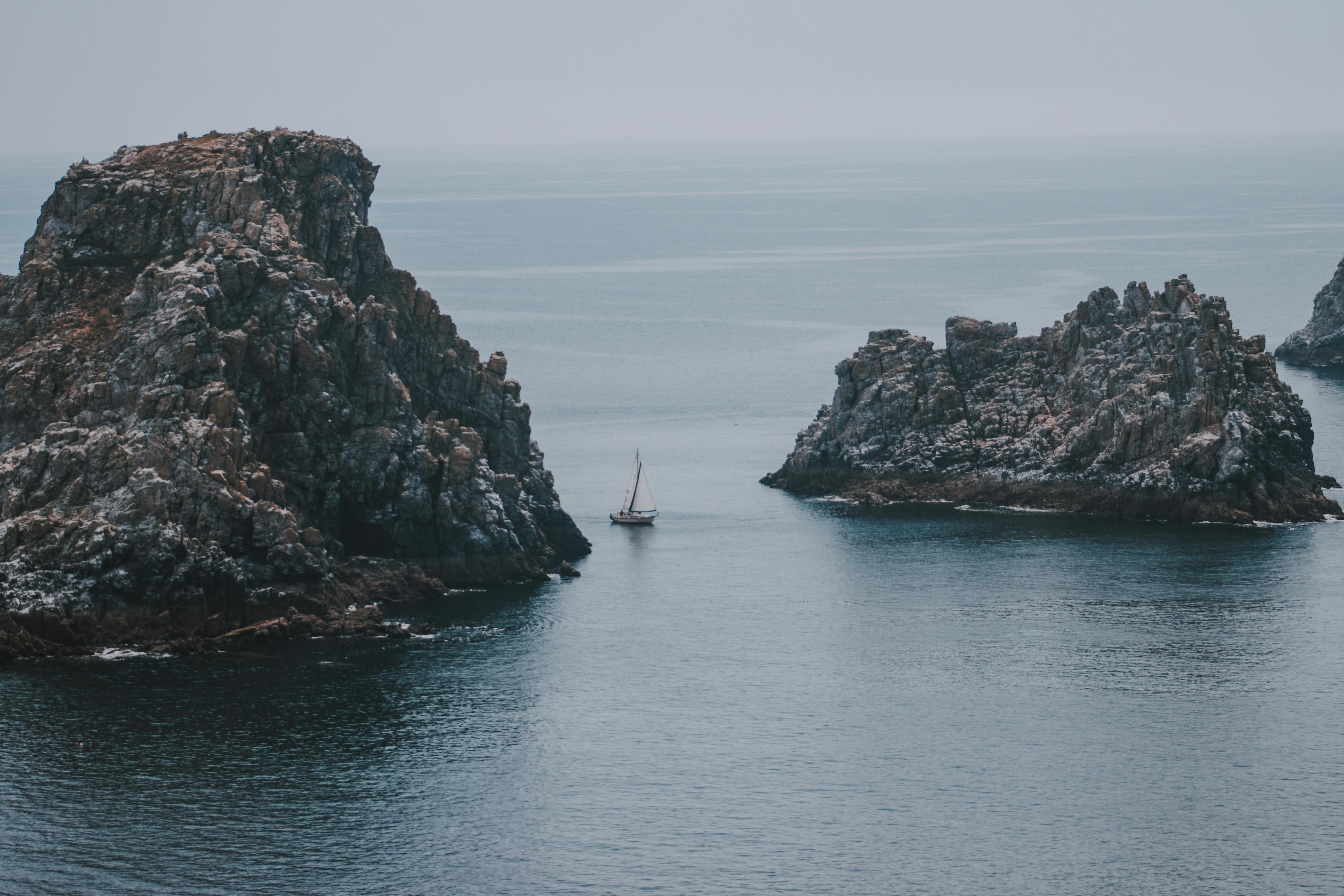 Sailboat between Rocks · Free Stock Photo