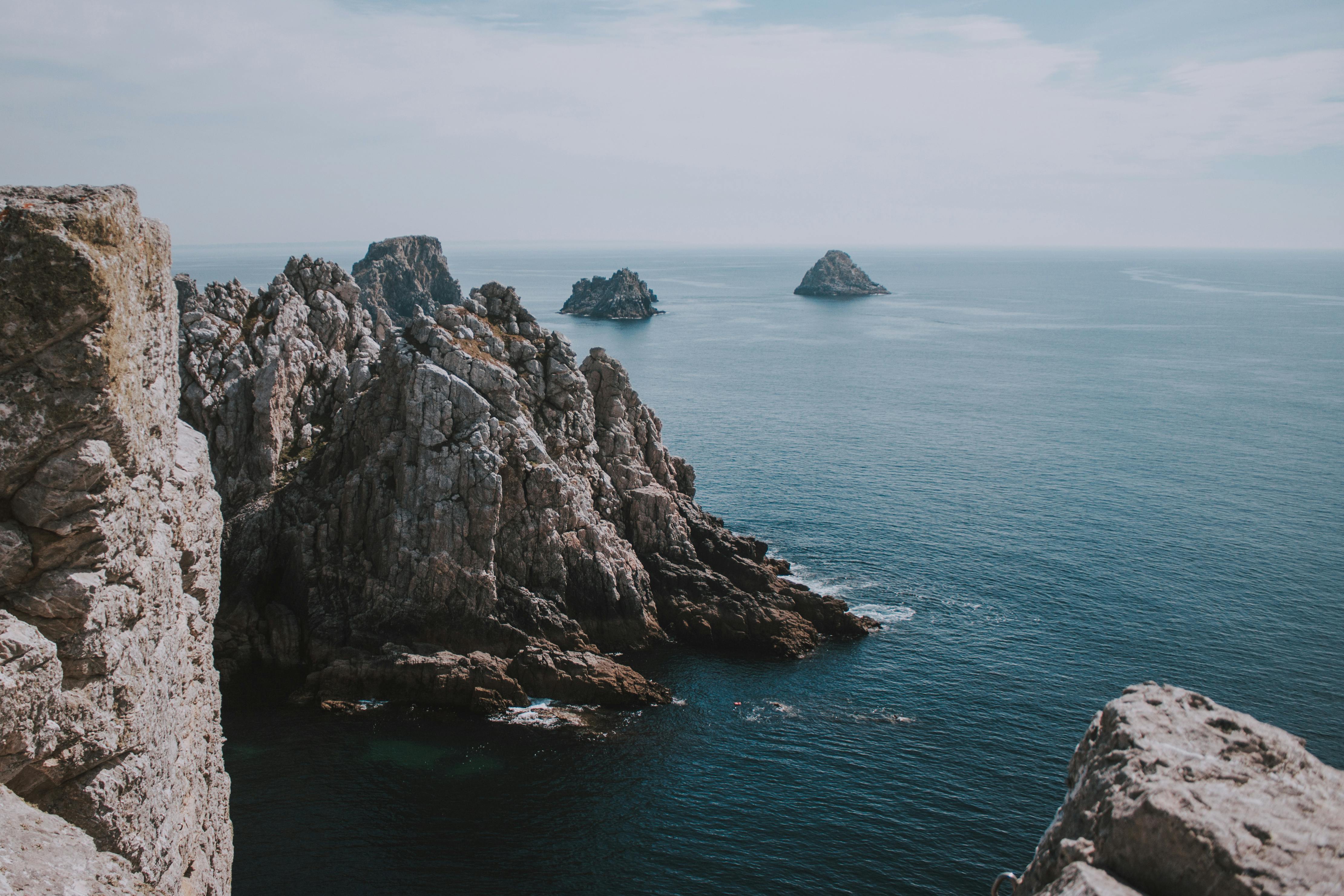 Seascape with rocks under blue sky · Free Stock Photo