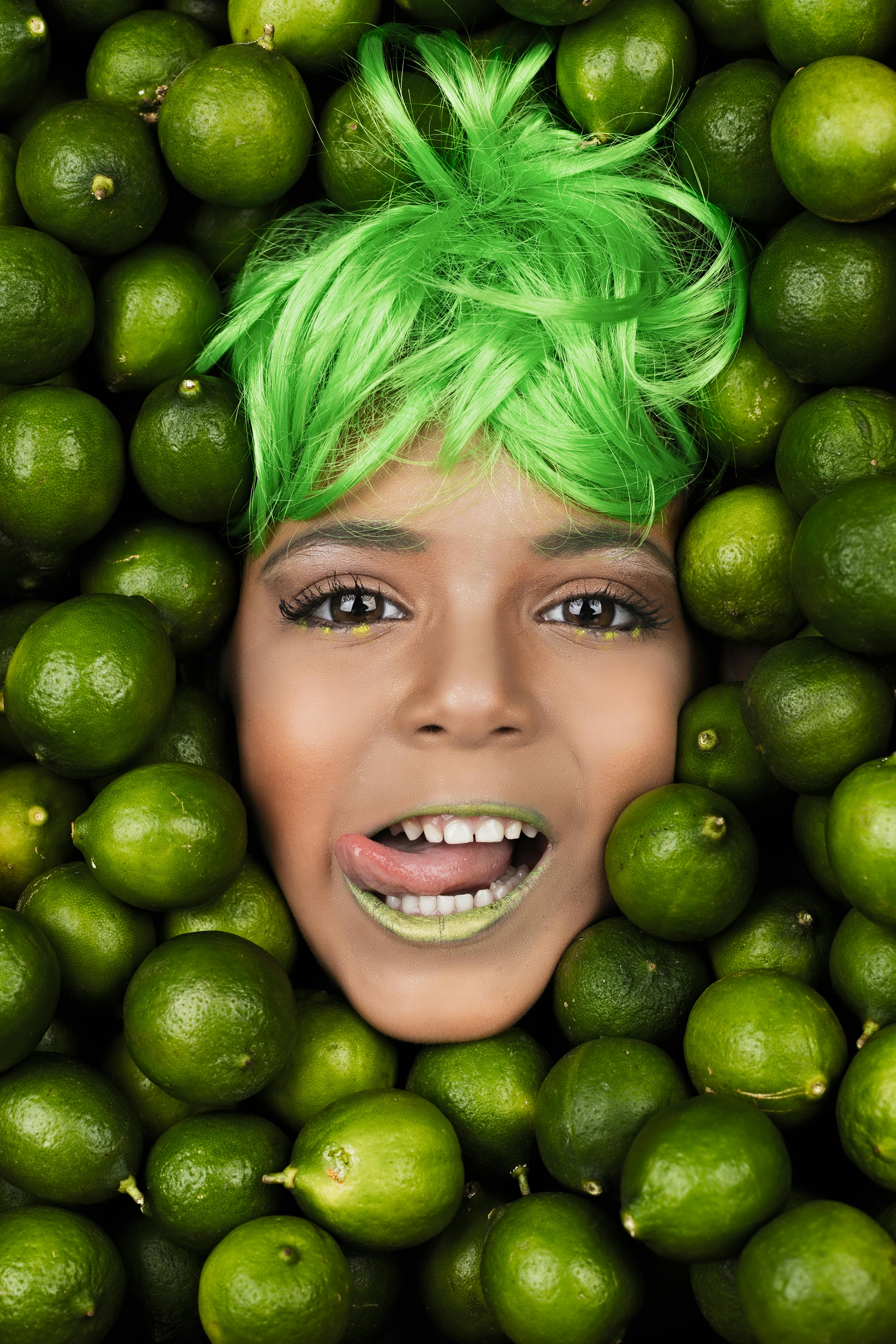 Womans Face Surrounded by Limes · Free Stock Photo