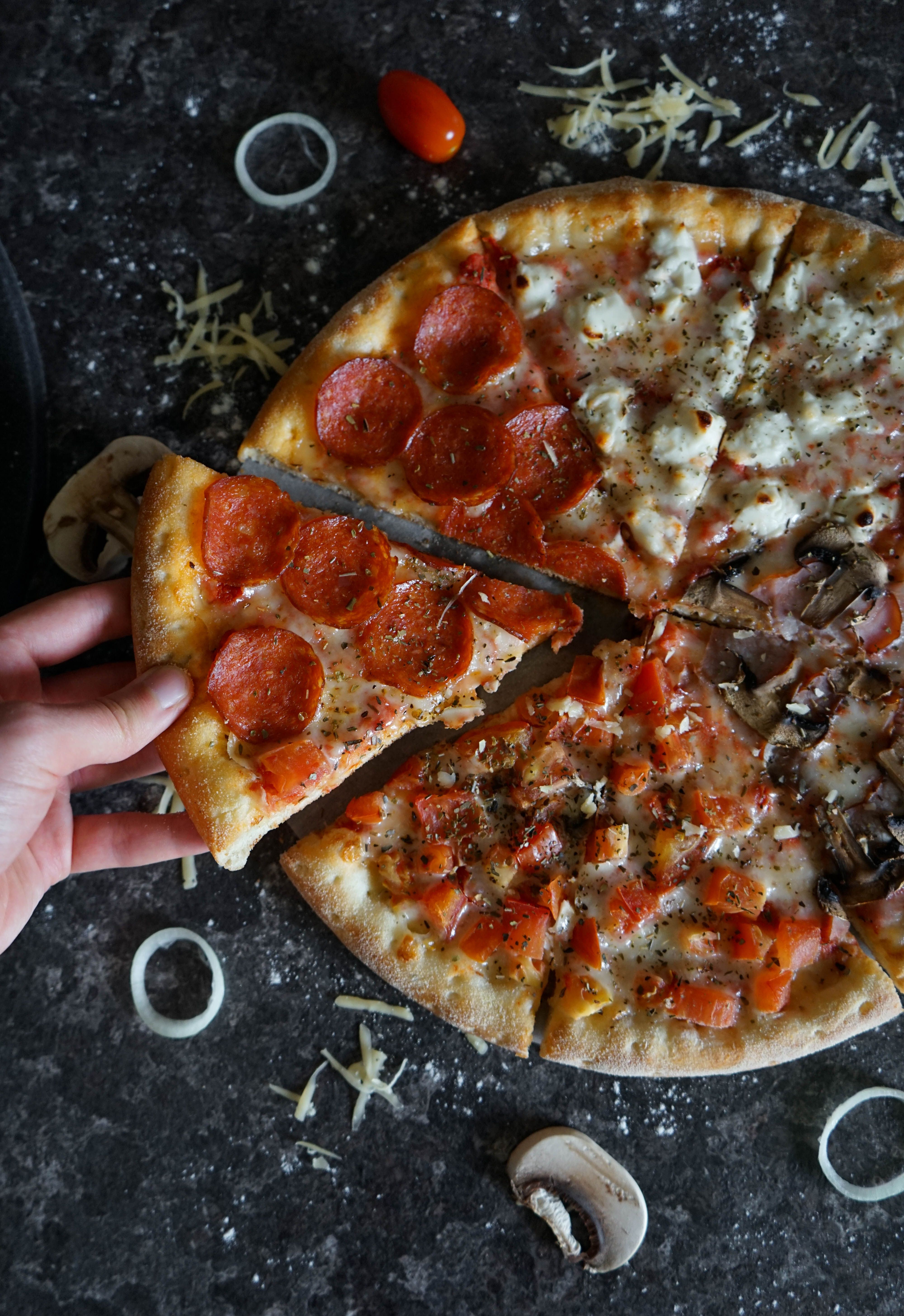 Crop person with delicious slice of pizza · Free Stock Photo
