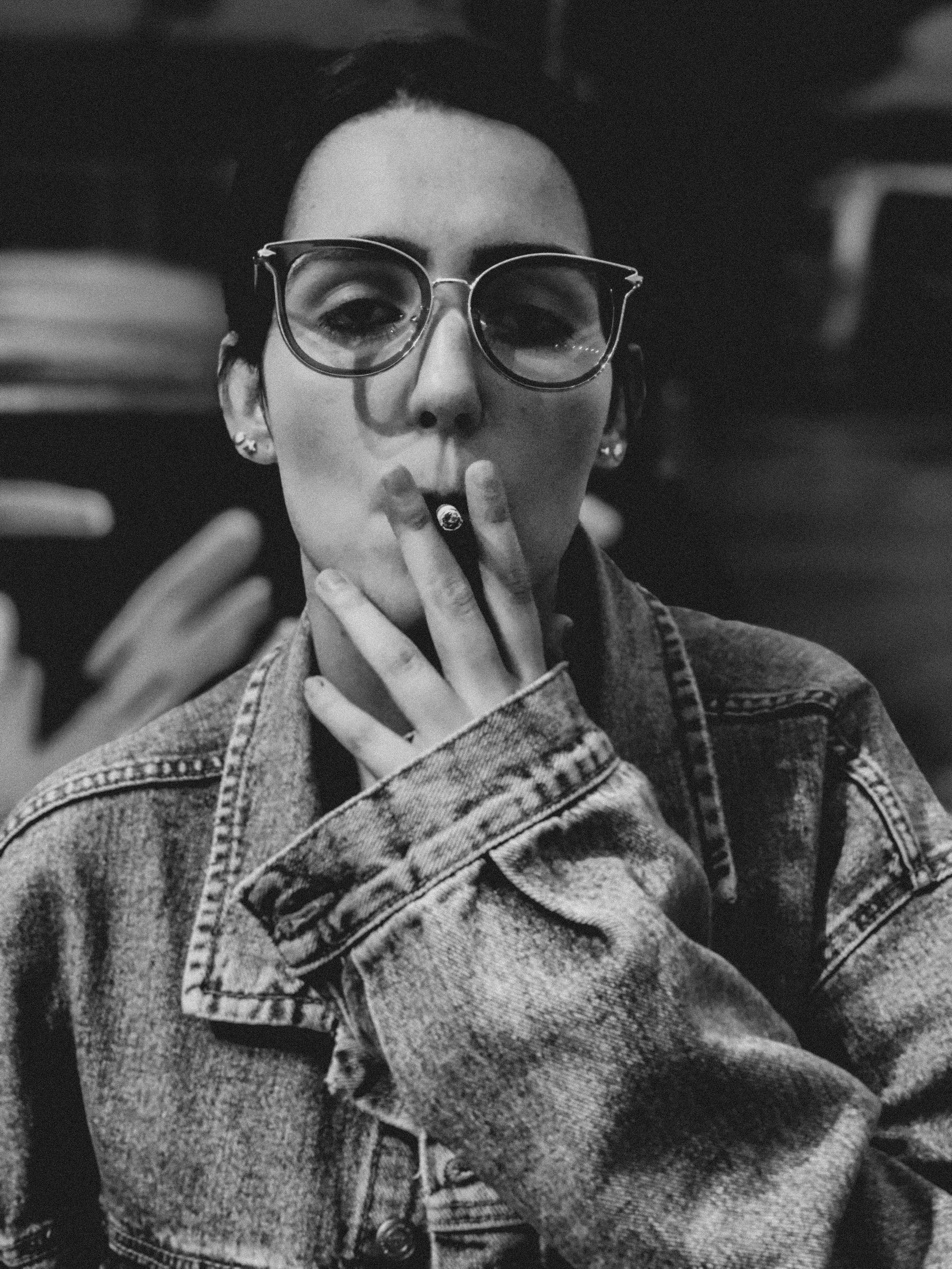 Monochrome Photo of a Woman in a Denim Jacket Smoking a Cigarette ...