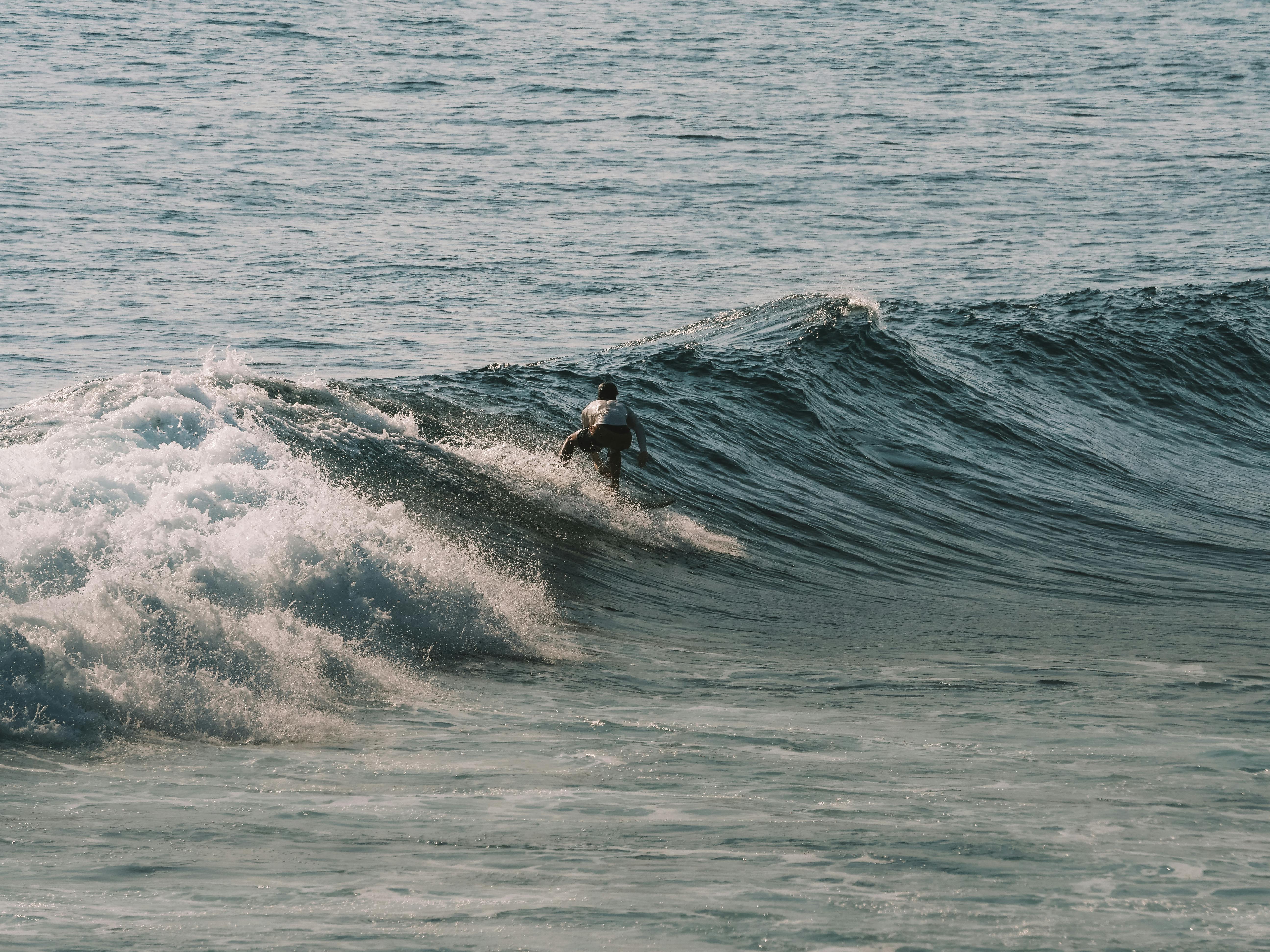 Photo of a Person Surfing on a Big Sea Wave · Free Stock Photo