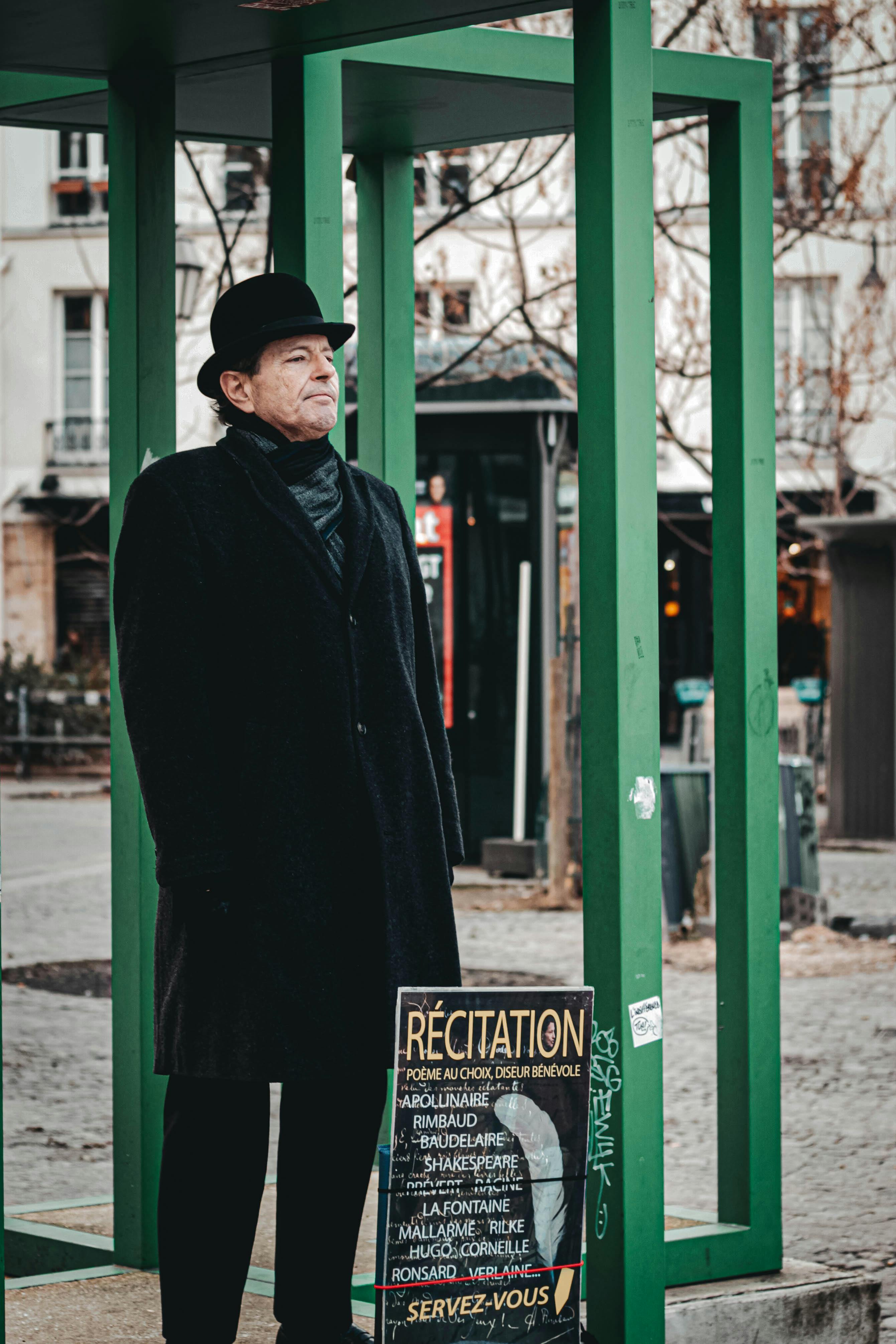 Serious young man adjusting coat on snowy terrain on winter day · Free ...