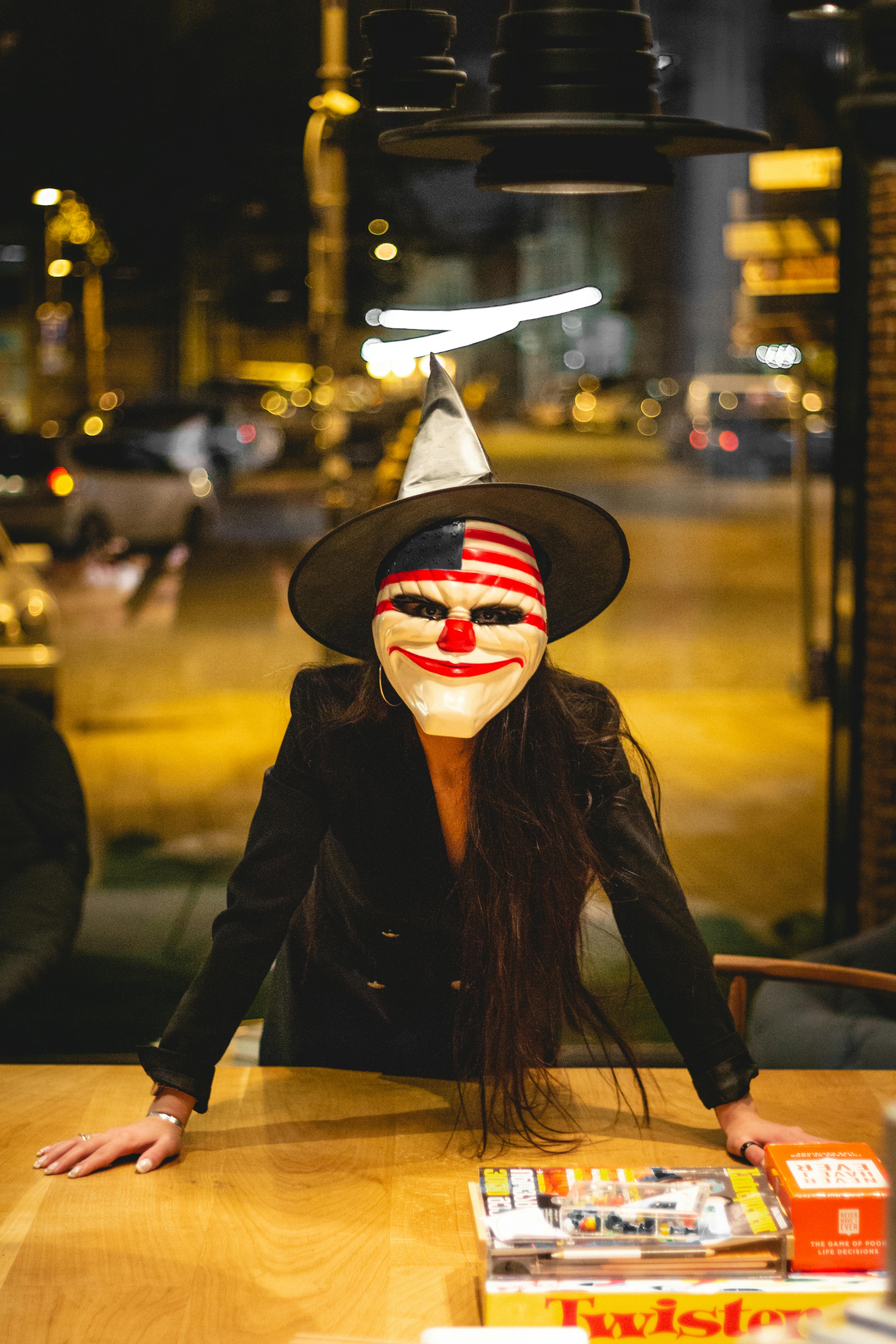 Woman in Clown Mask and Wizard Hat · Free Stock Photo