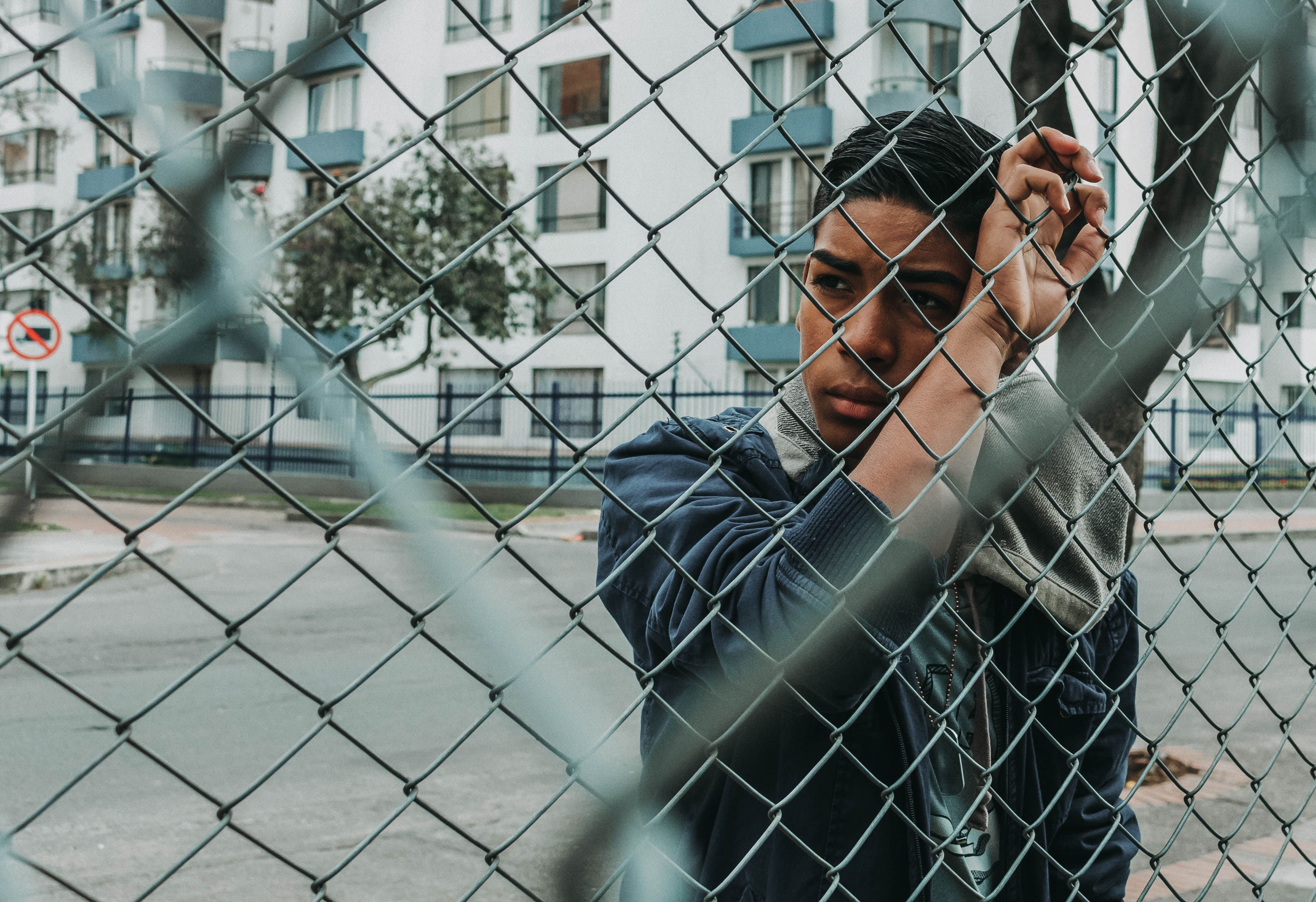 Man Holding Fence · Free Stock Photo