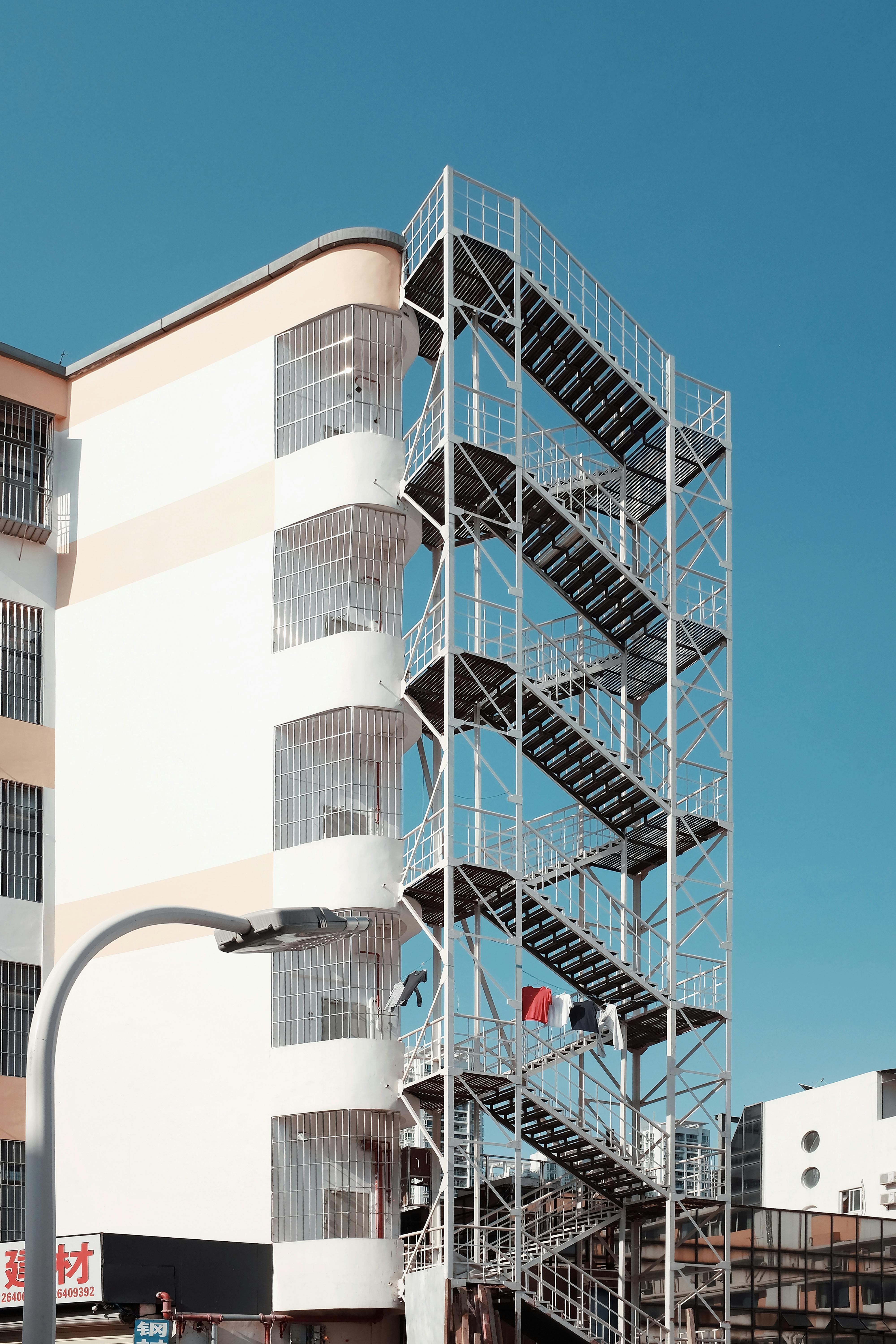 Modern multistage building with stairs under blue sky · Free Stock Photo