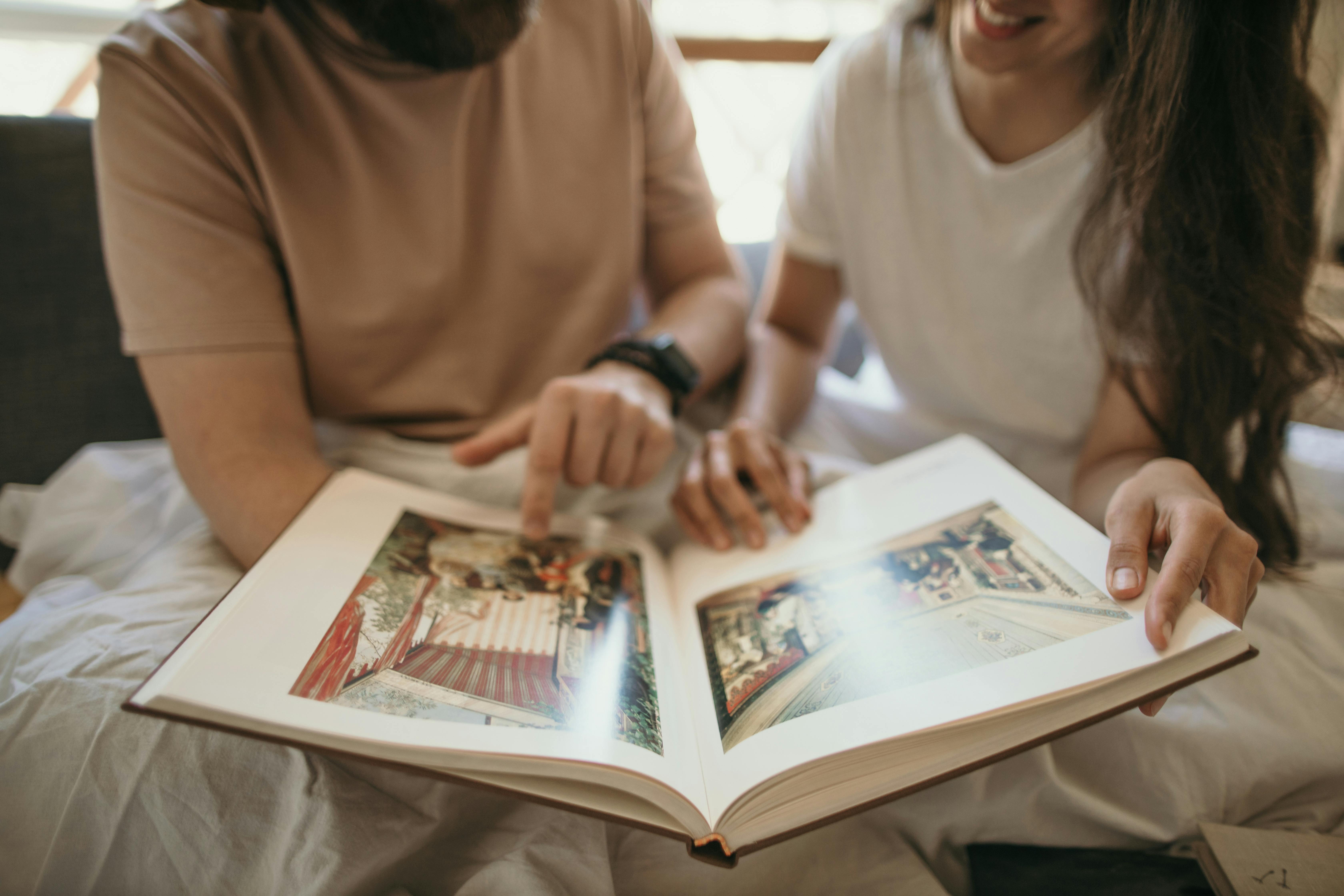People Reading a Book Together · Free Stock Photo