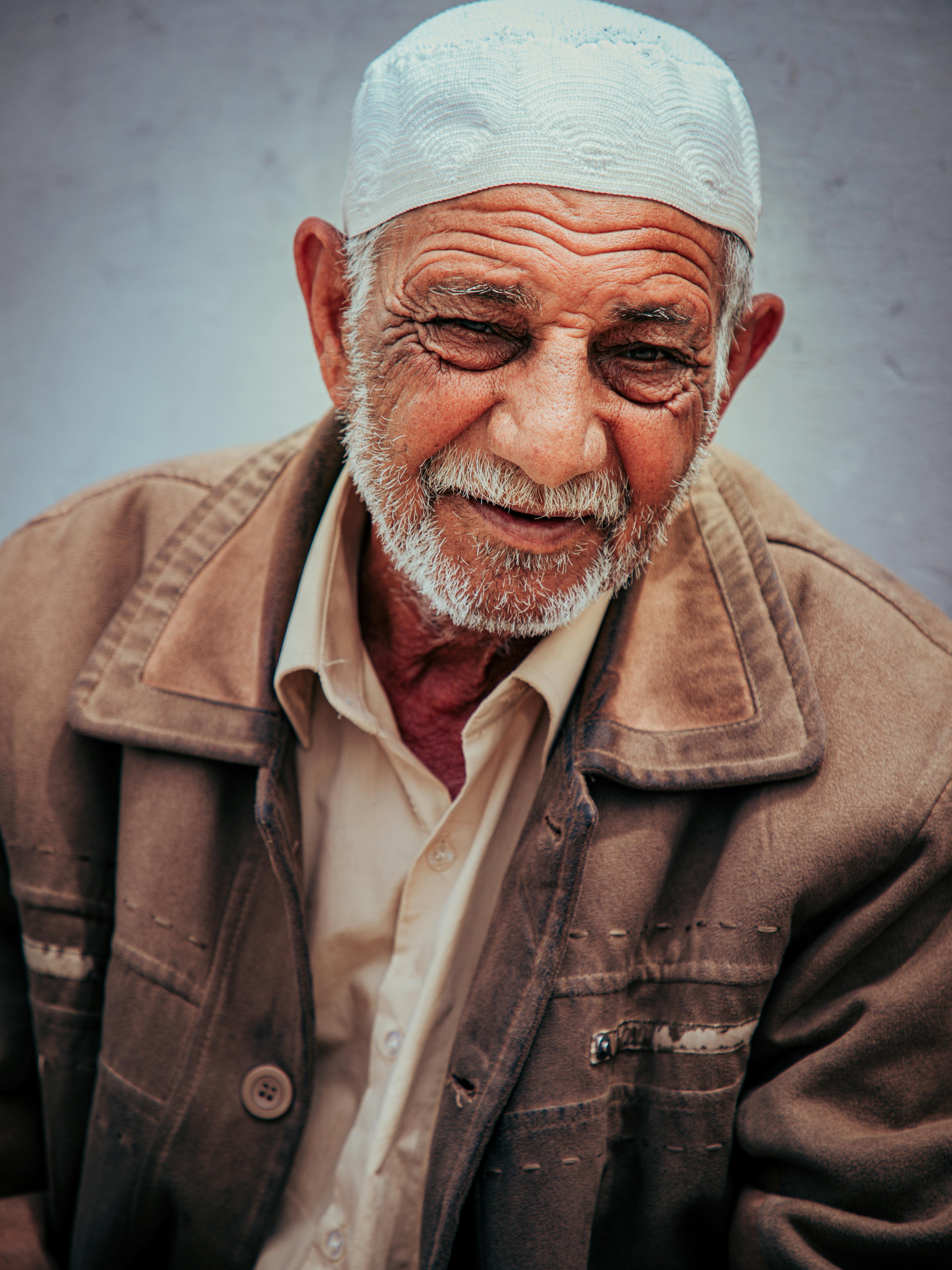 Man in Brown Sweater Smiling · Free Stock Photo