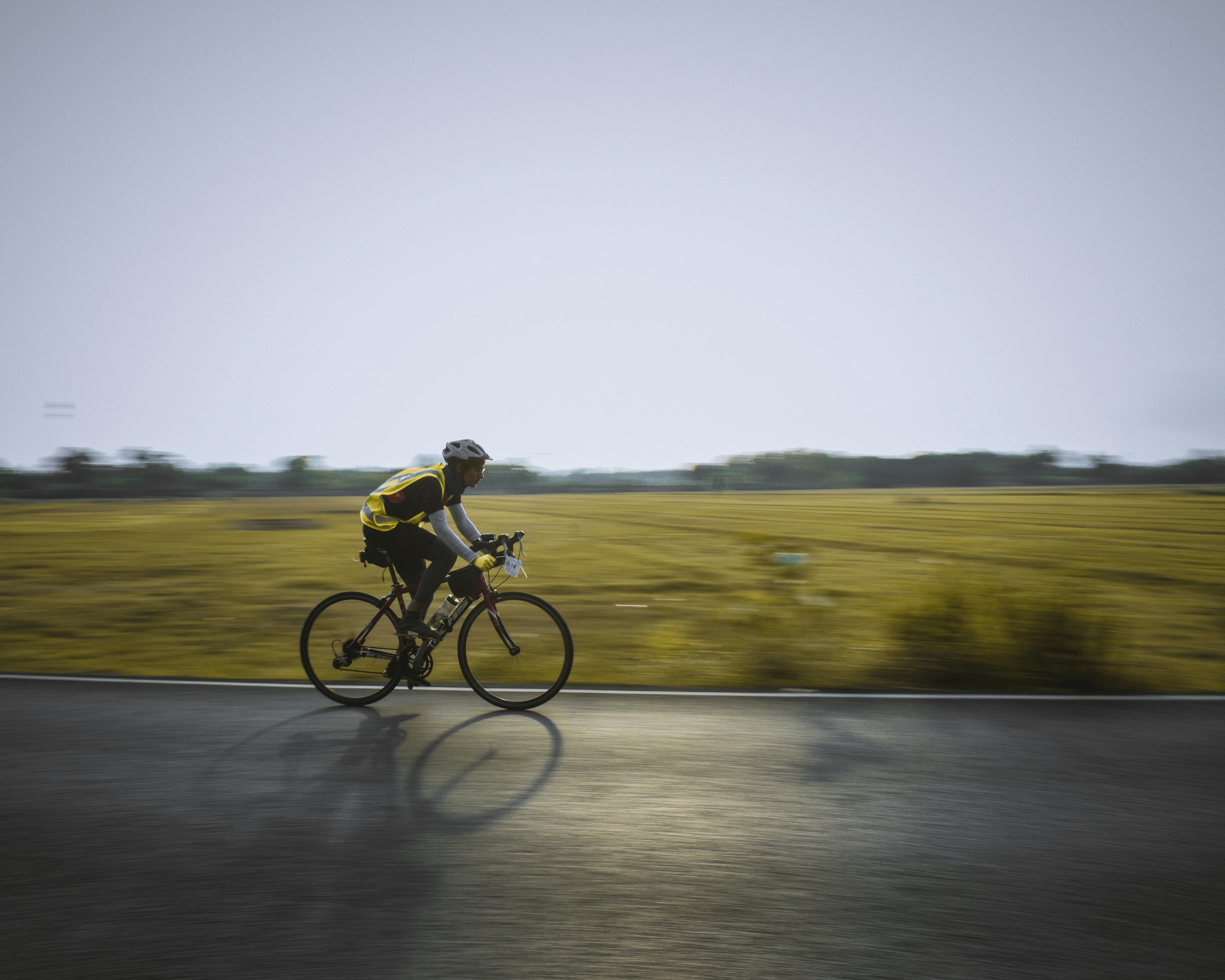 Anonymous kid in helmet riding run bike on pavement in countryside ...