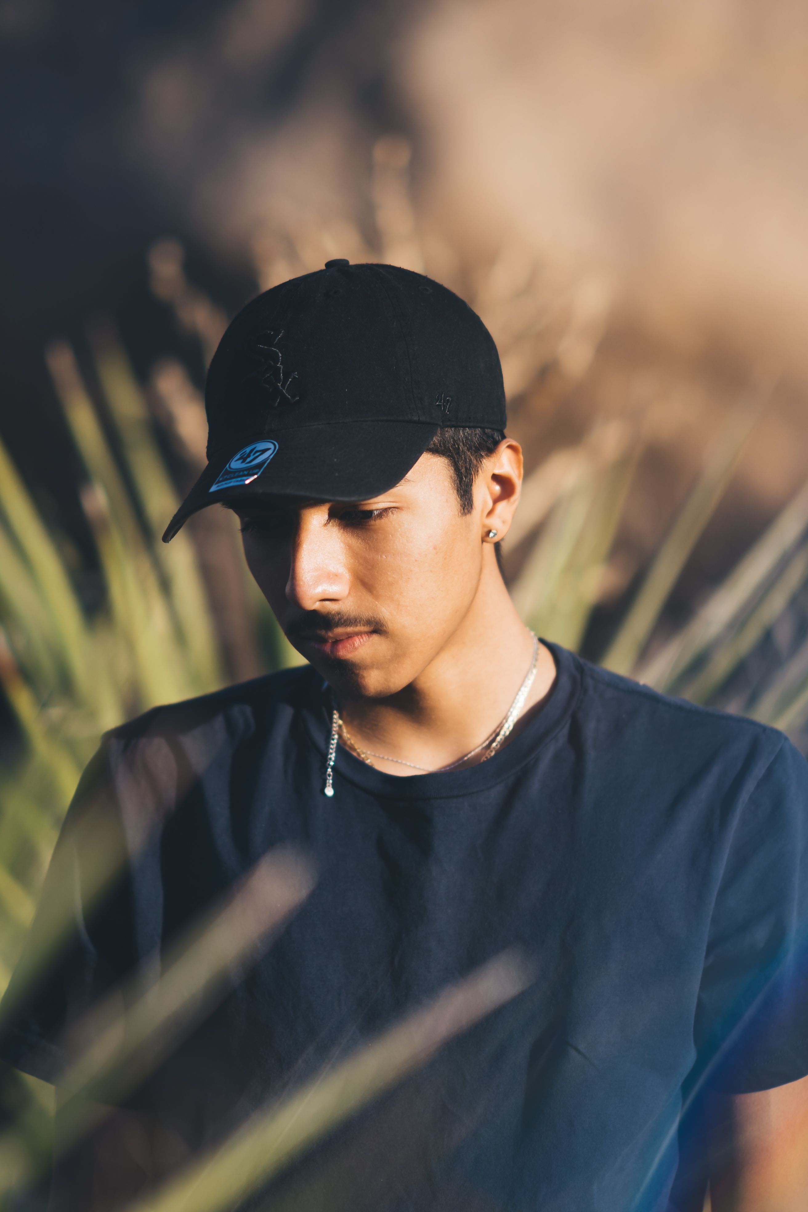 Young ethnic man amidst desert plants · Free Stock Photo