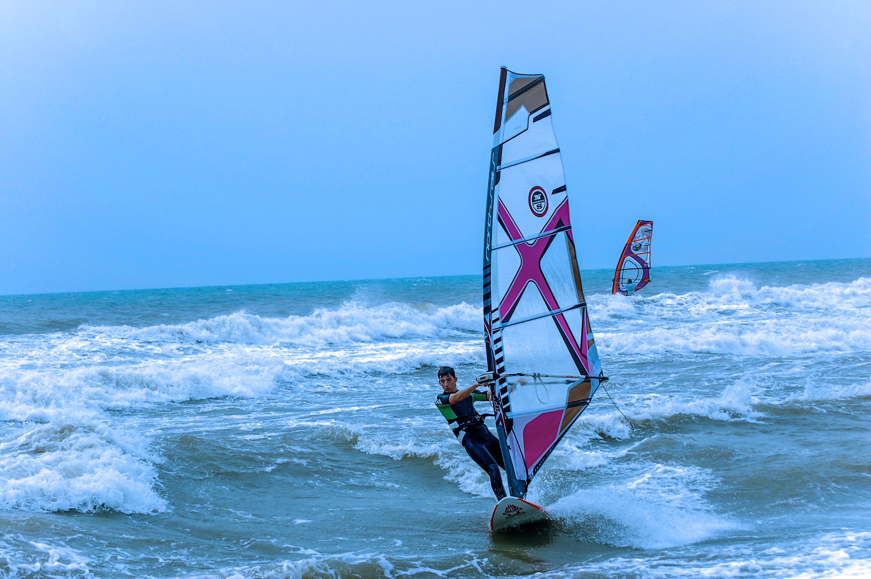 Photo of a Man Windsurfing at the Beach · Free Stock Photo
