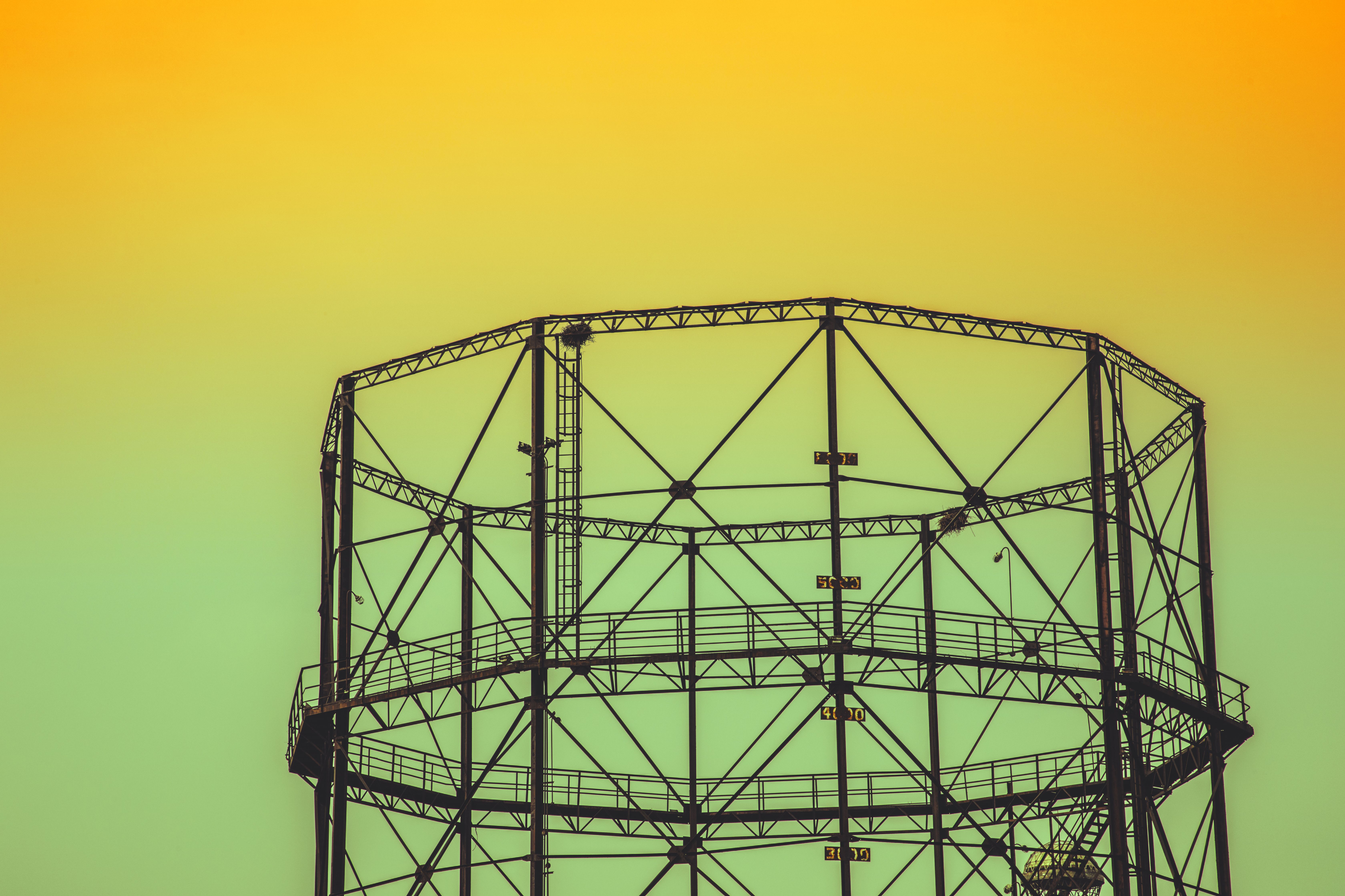 Person standing under a Steel Metal Stucture · Free Stock Photo