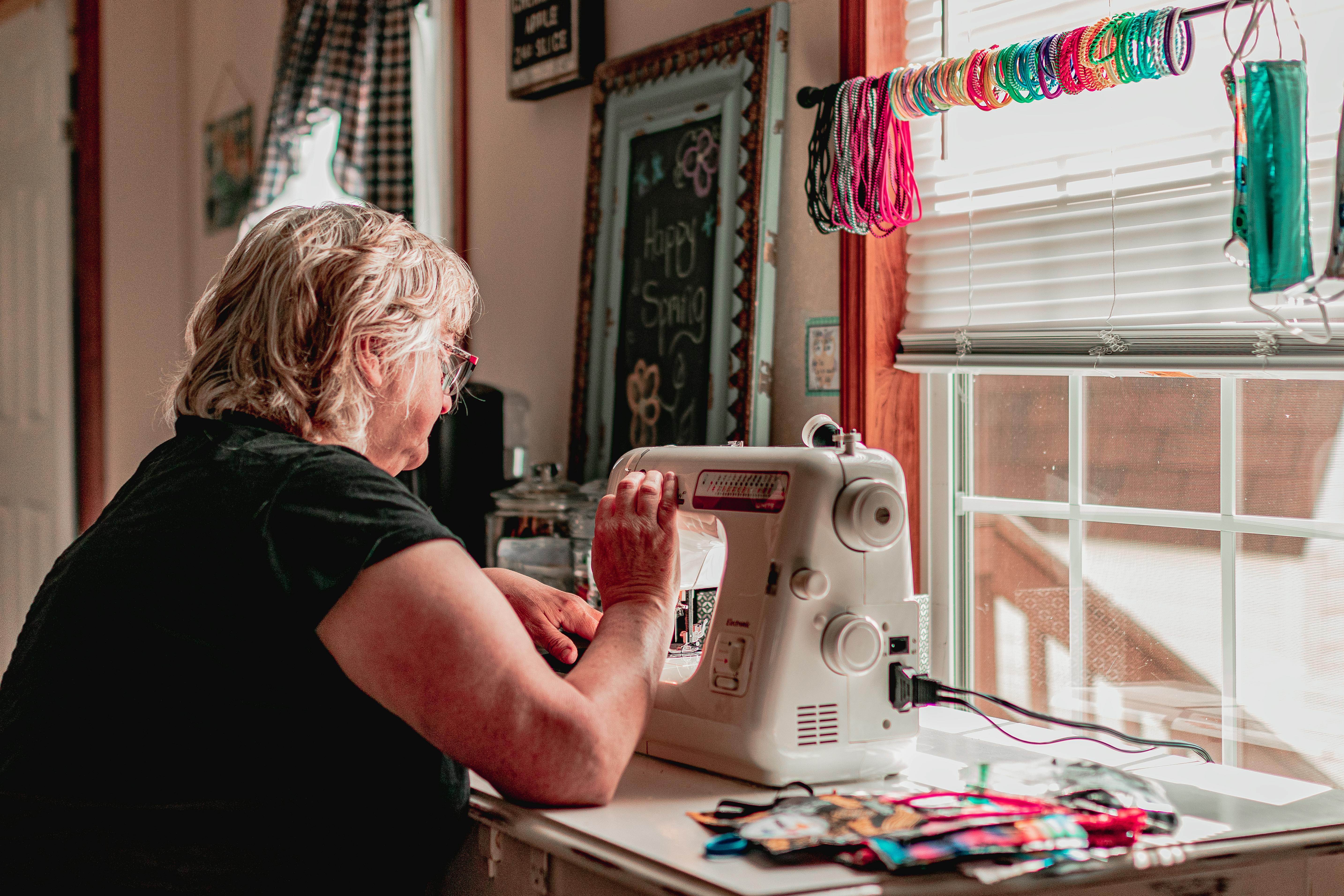 Woman in Black Shirt Using White Sewing Machine · Free Stock Photo