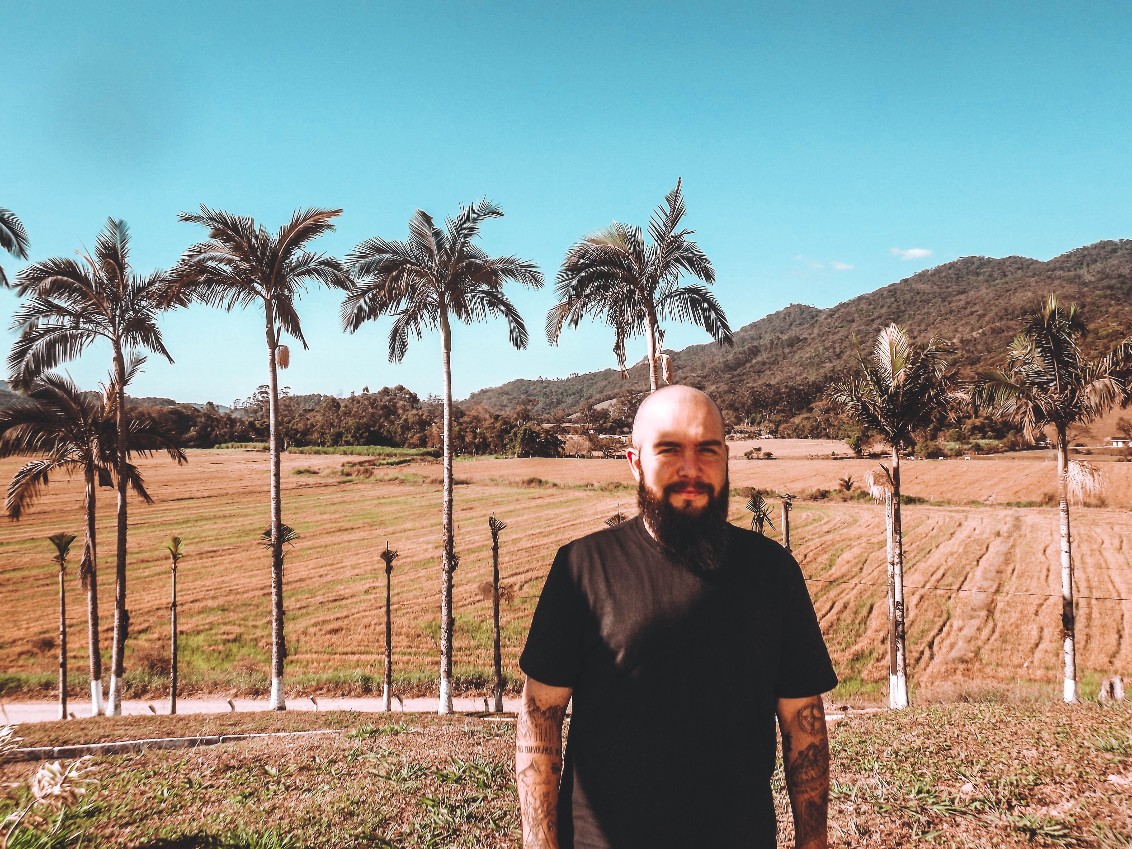 Portrait of a Man with Palm Trees in the Background · Free Stock Photo
