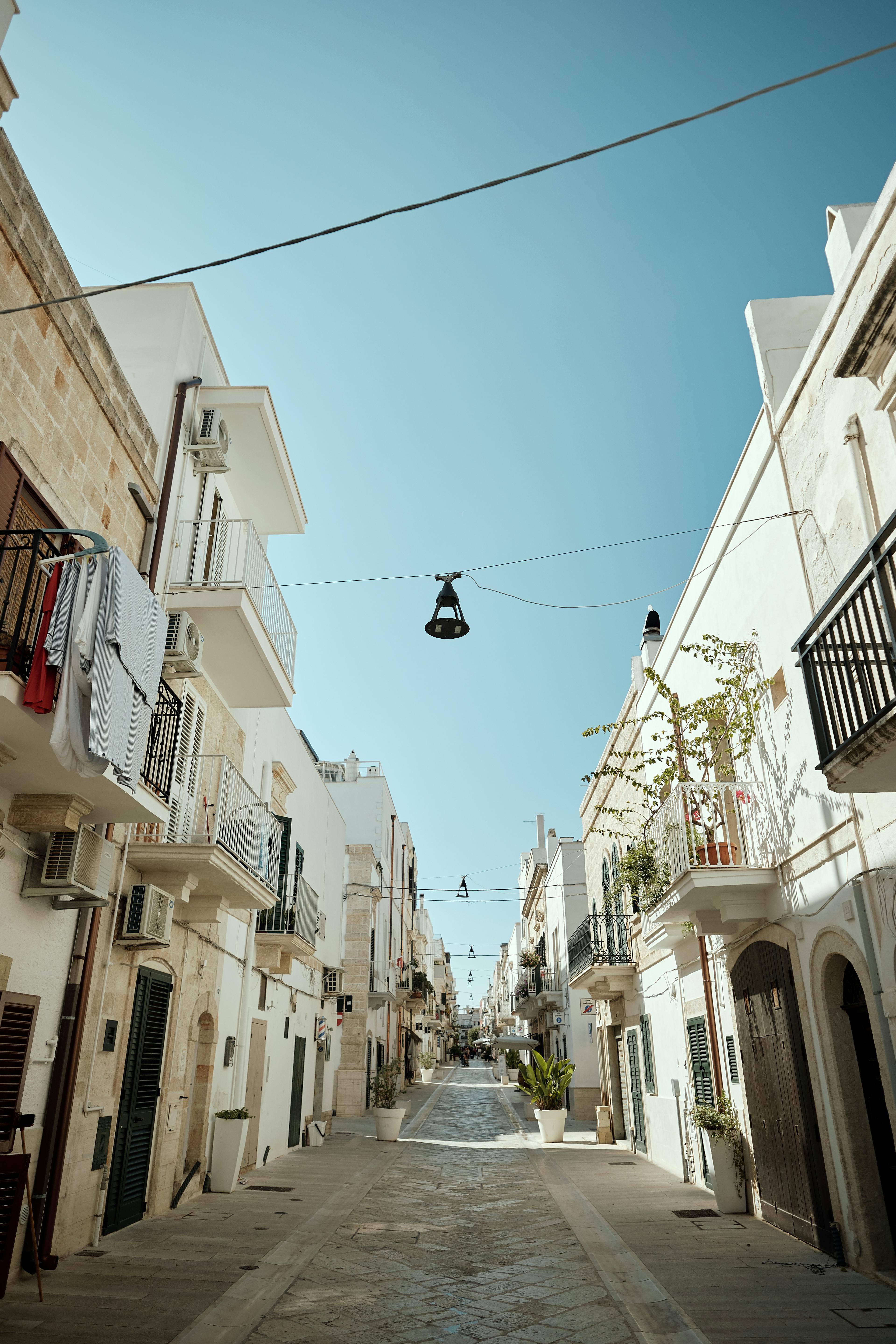 Narrow pathway between blue buildings · Free Stock Photo