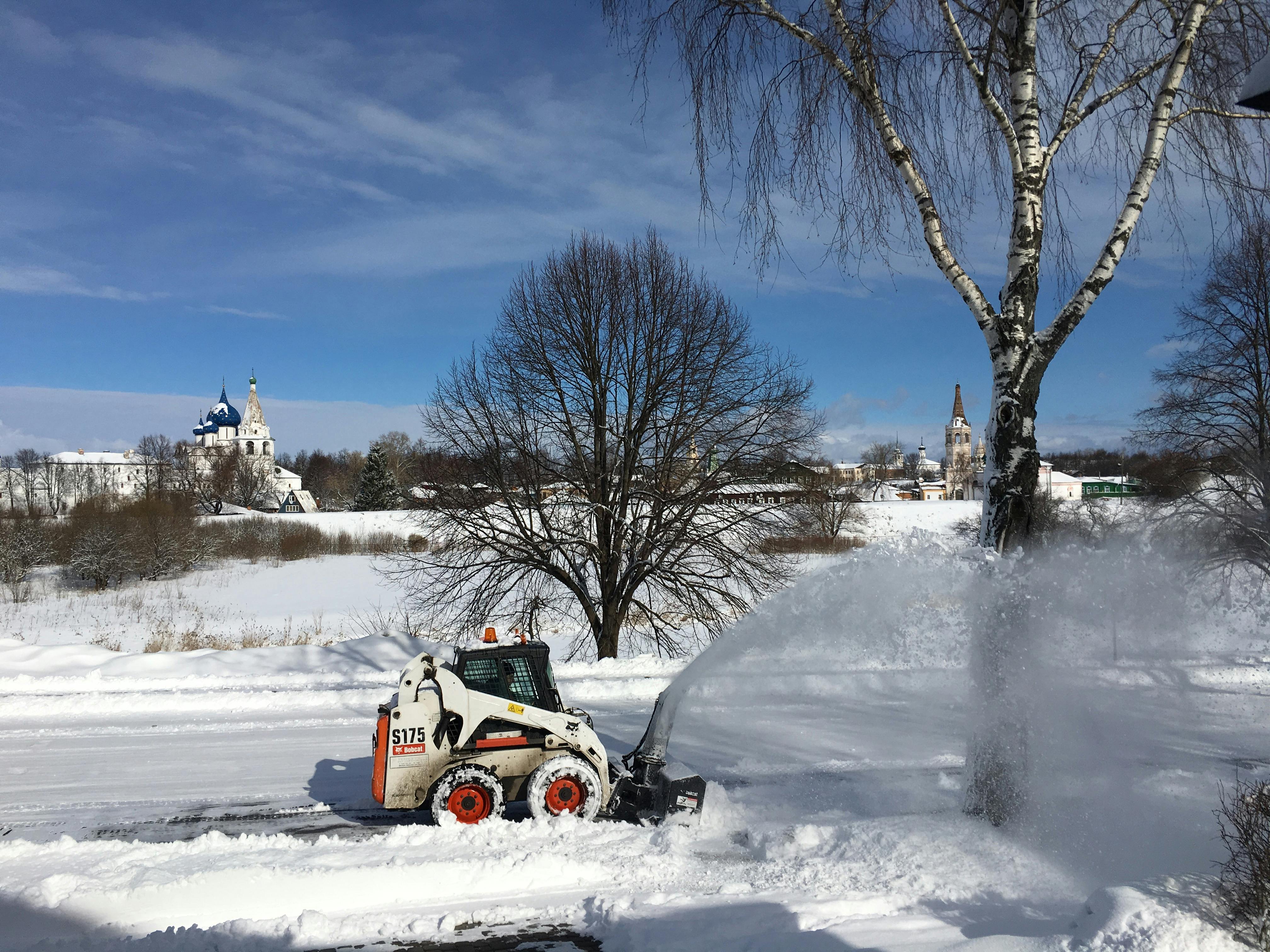 Snow cutter cleaning snowy road in countryside · Free Stock Photo